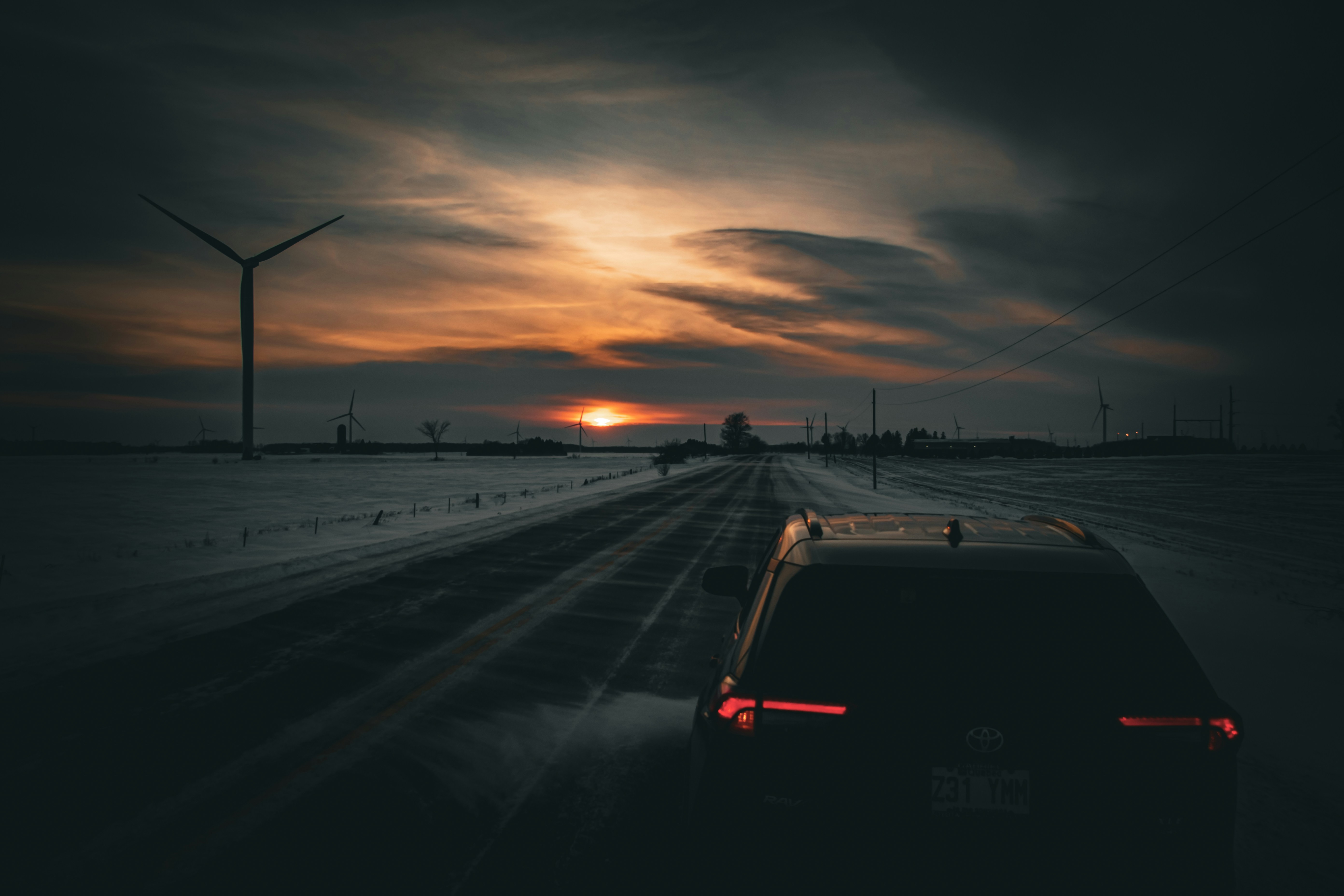 a car driving down a snow covered road