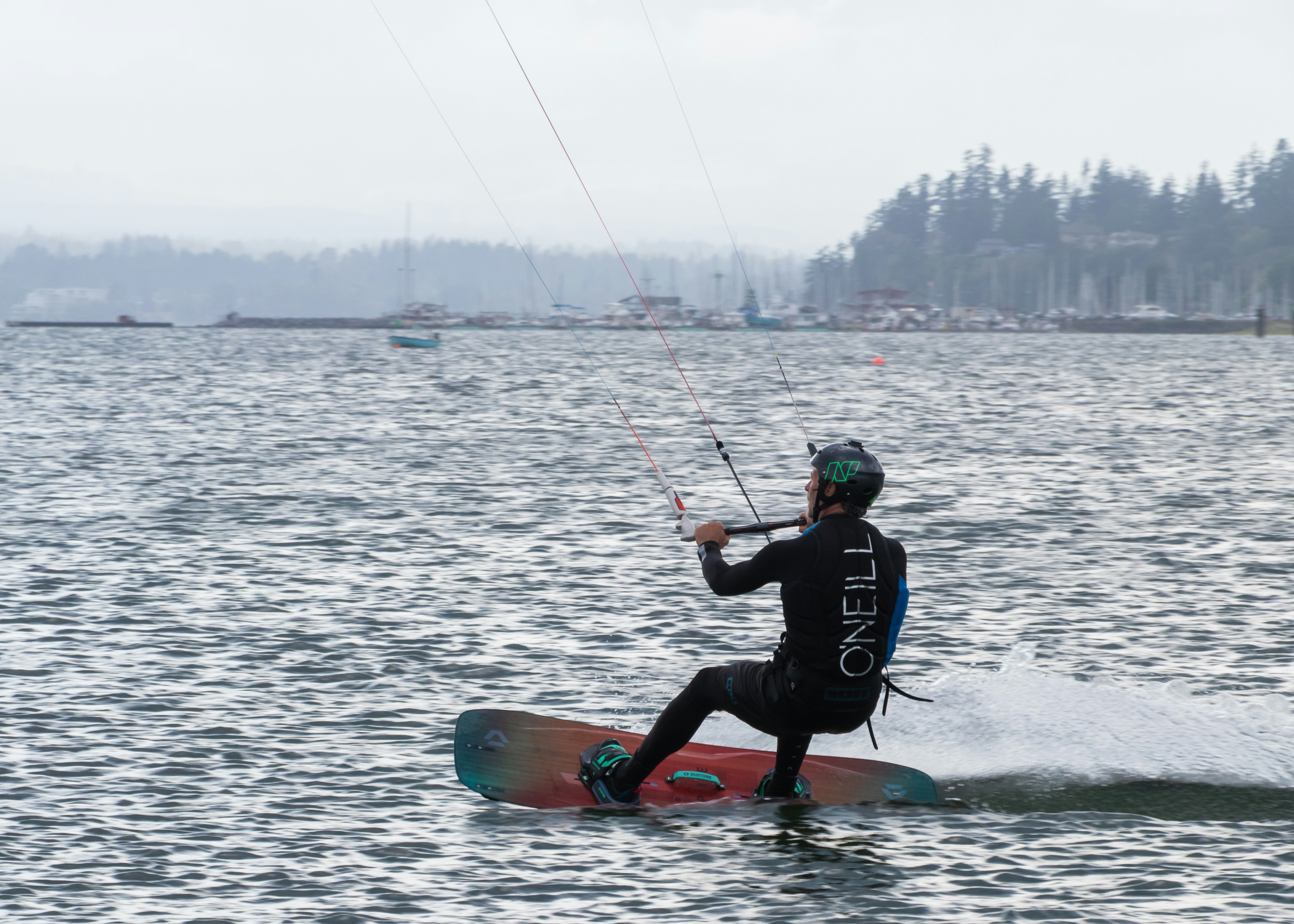 Kiteboarder Carves through a Choppy Blue Hour Wake