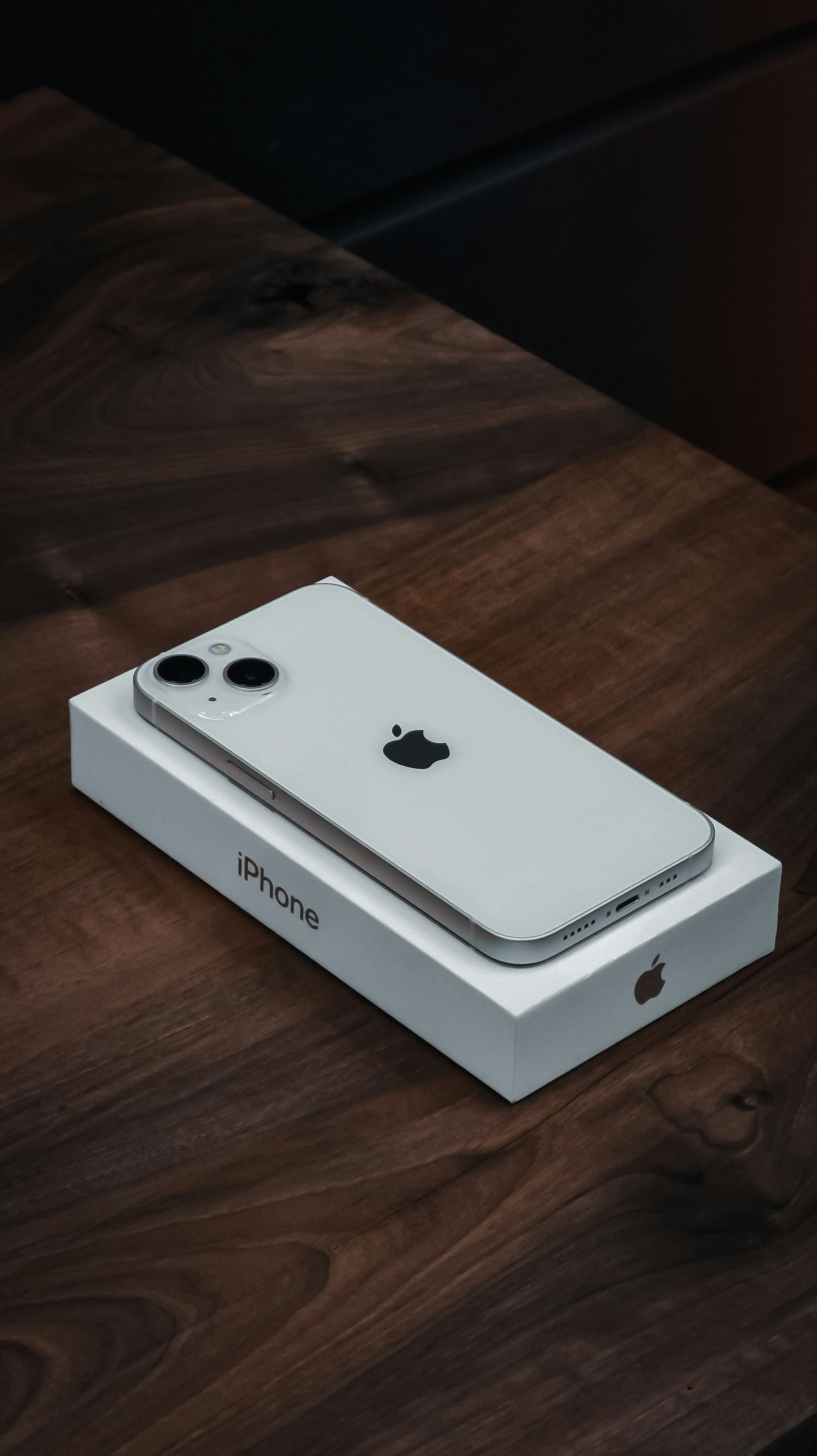 An iphone box sitting on top of a wooden table photo – Free Phone Image ...