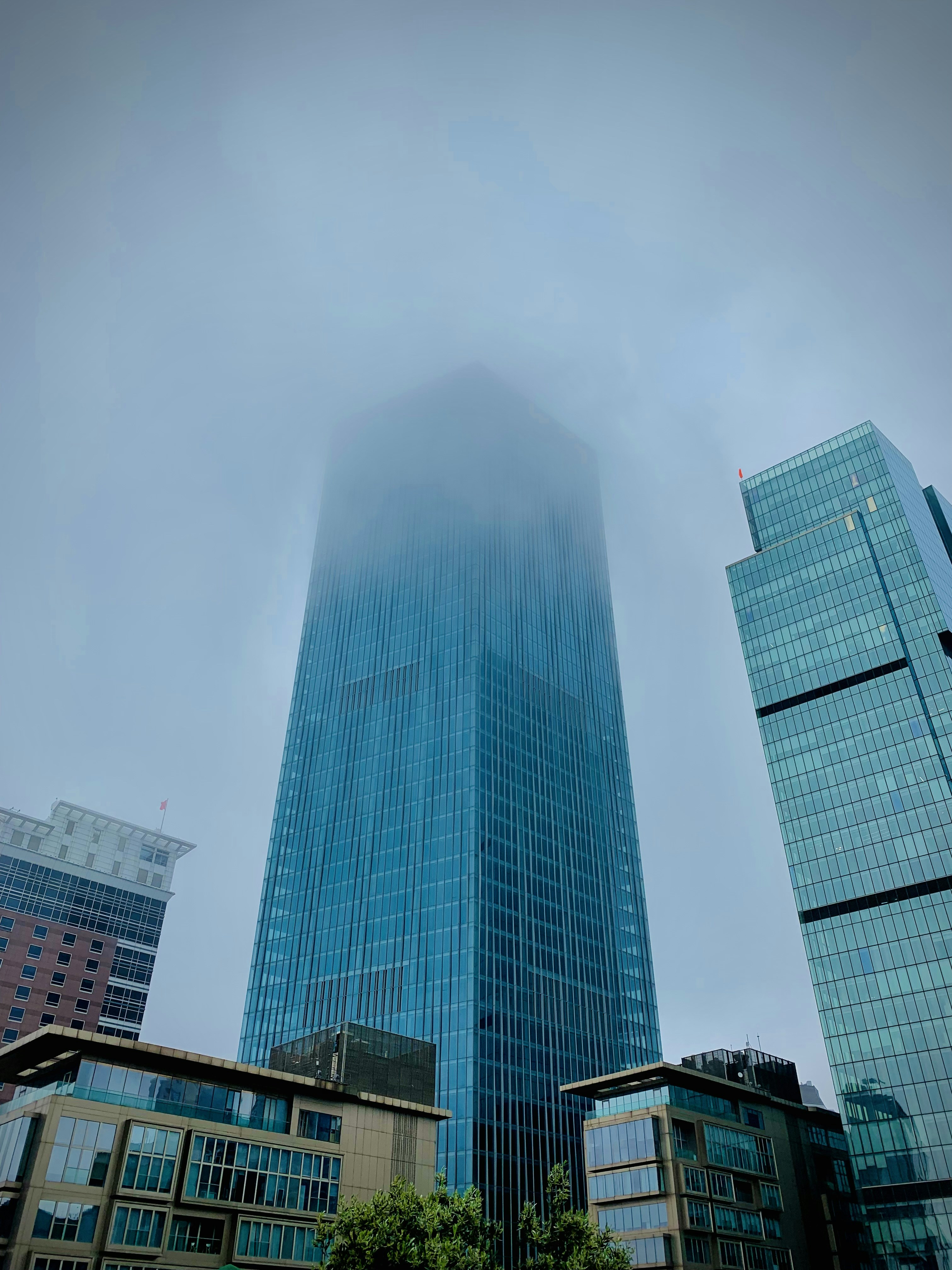 A very tall building surrounded by other tall buildings photo – Free ...