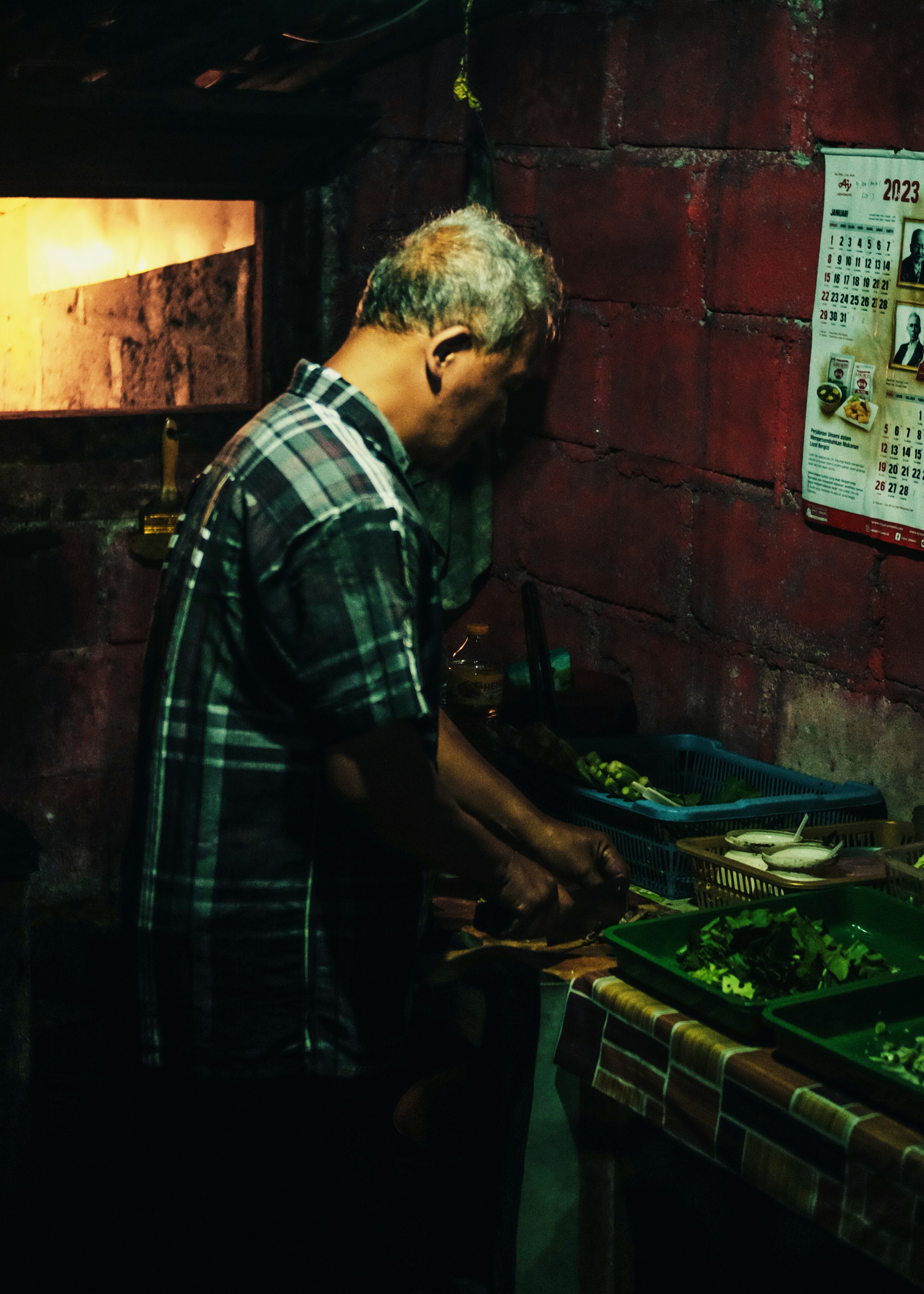 Warm Flame, Sharp Hands: Chopping at a Dim Street Kitchen