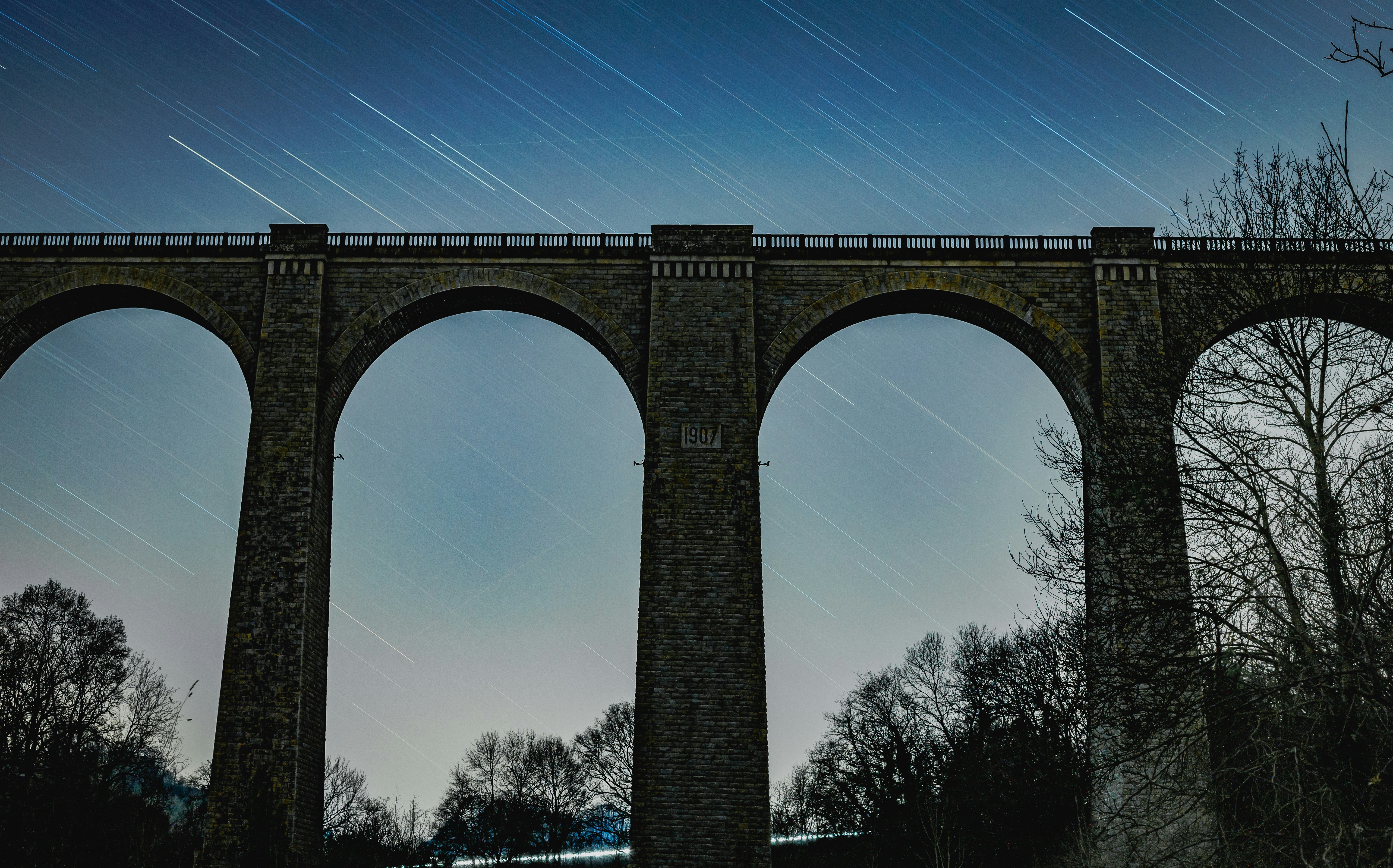 A bridge with arches and stars in the sky photo – Free Night Image on ...