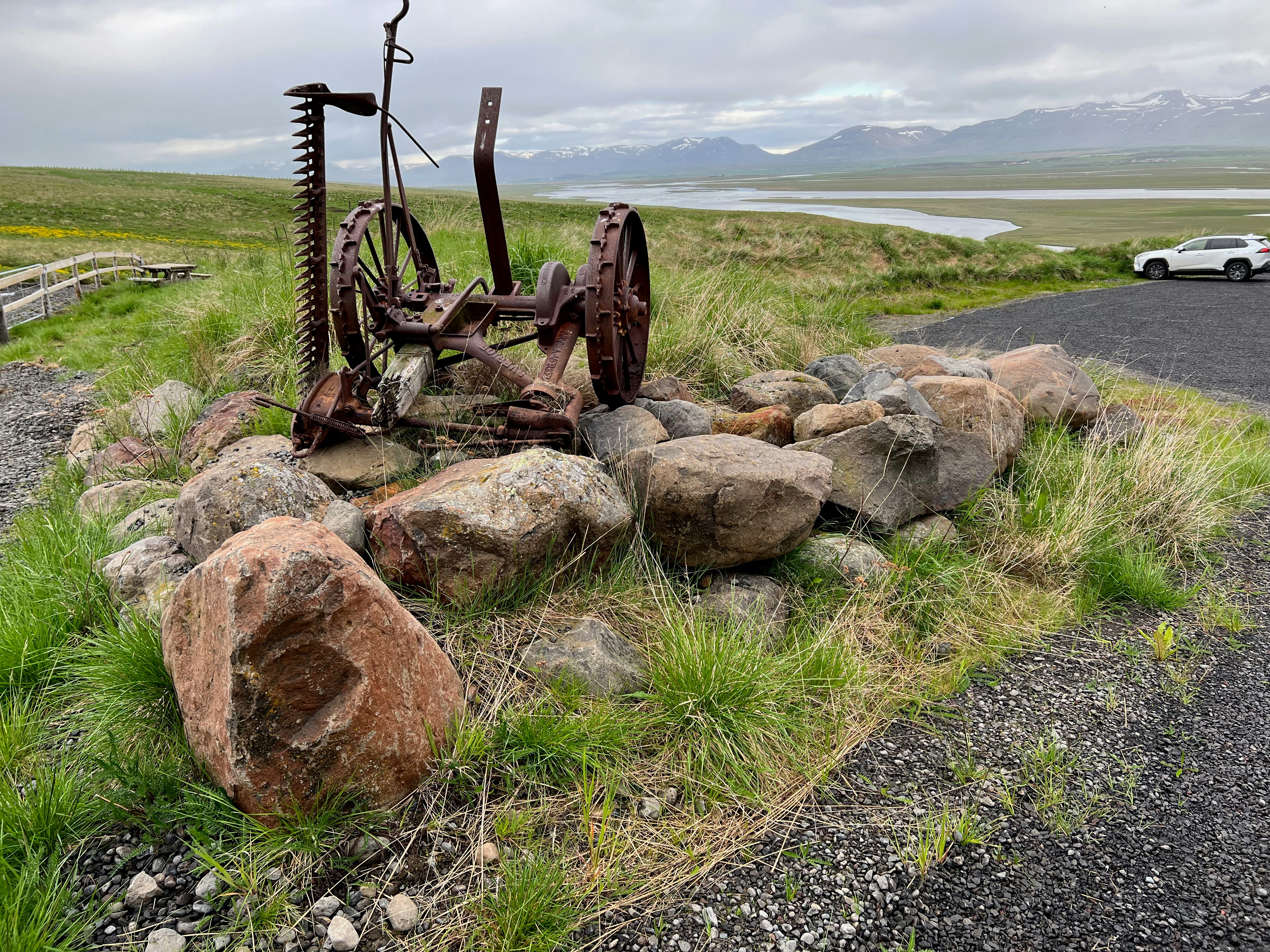 A rusted tractor sitting on top of a pile of rocks photo – Free Iceland ...