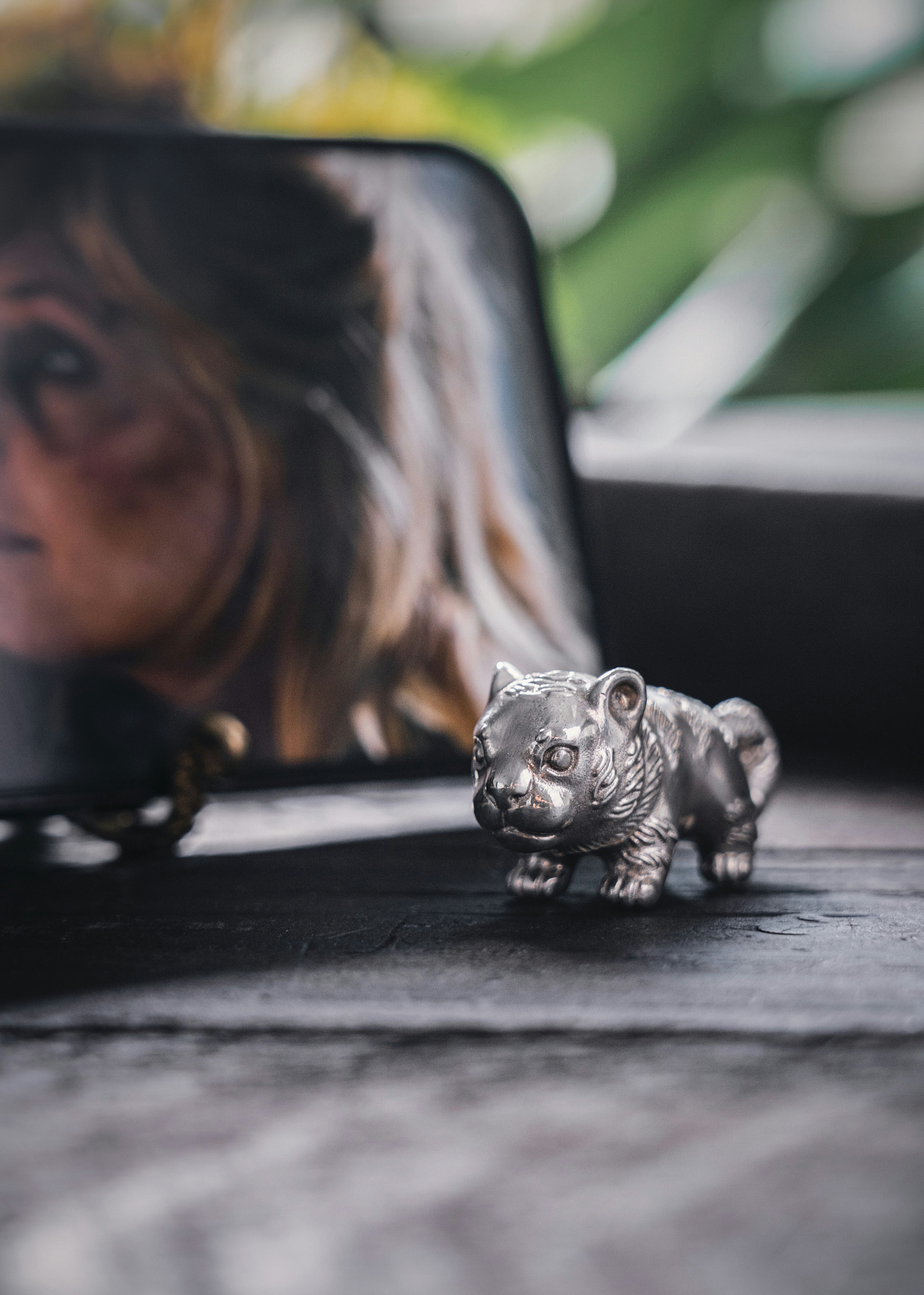 A silver cat figurine sitting on top of a table photo – Free ...