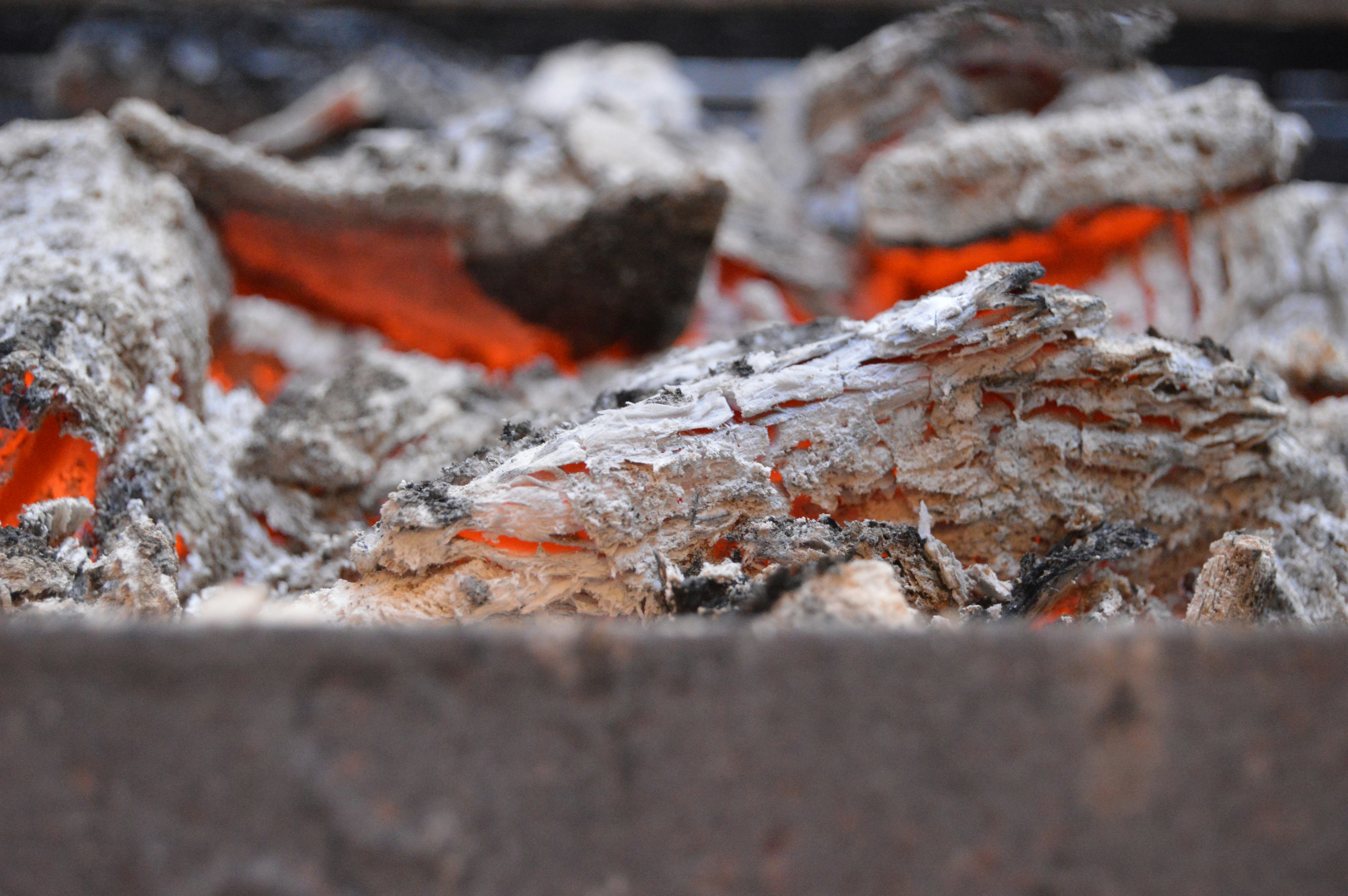 Ember Crumbs: Close-Up of Charred Coals in a Grill