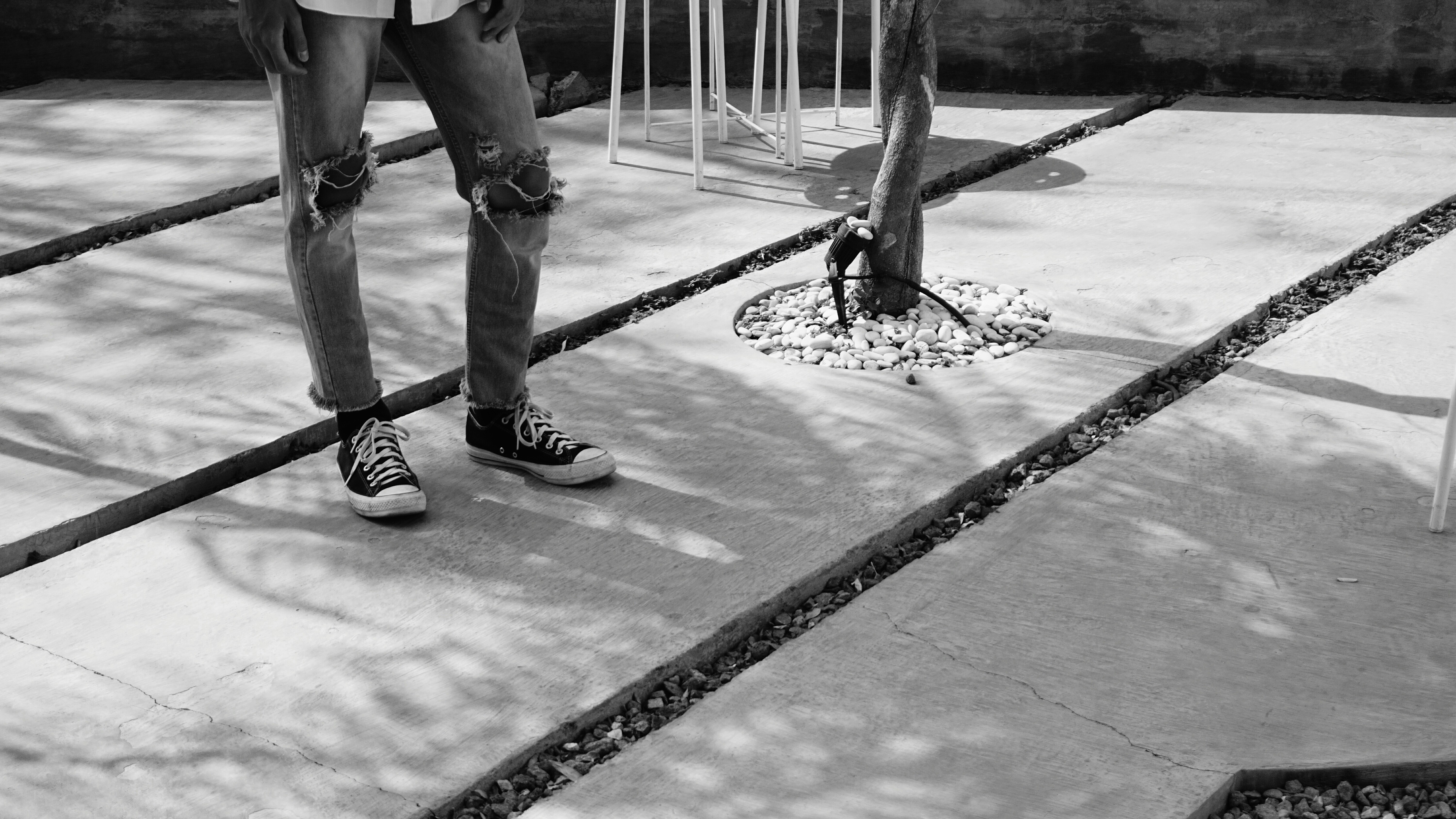 Pebble-Ringed Void Under Striped Shade: A Quiet Courtyard Moment
