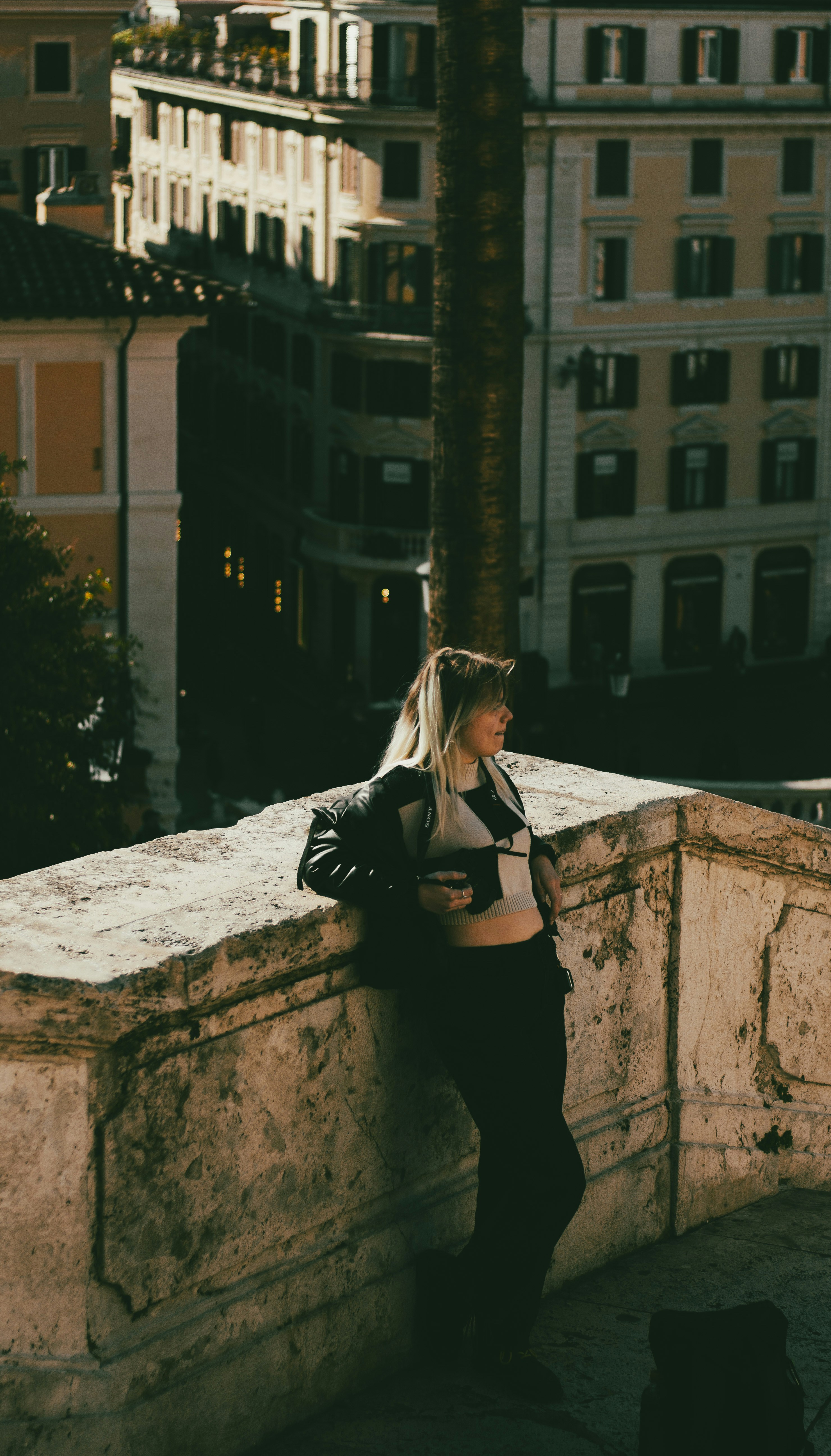 Rooftop Glimpses: Woman in Leather on a Sunlit Terrace