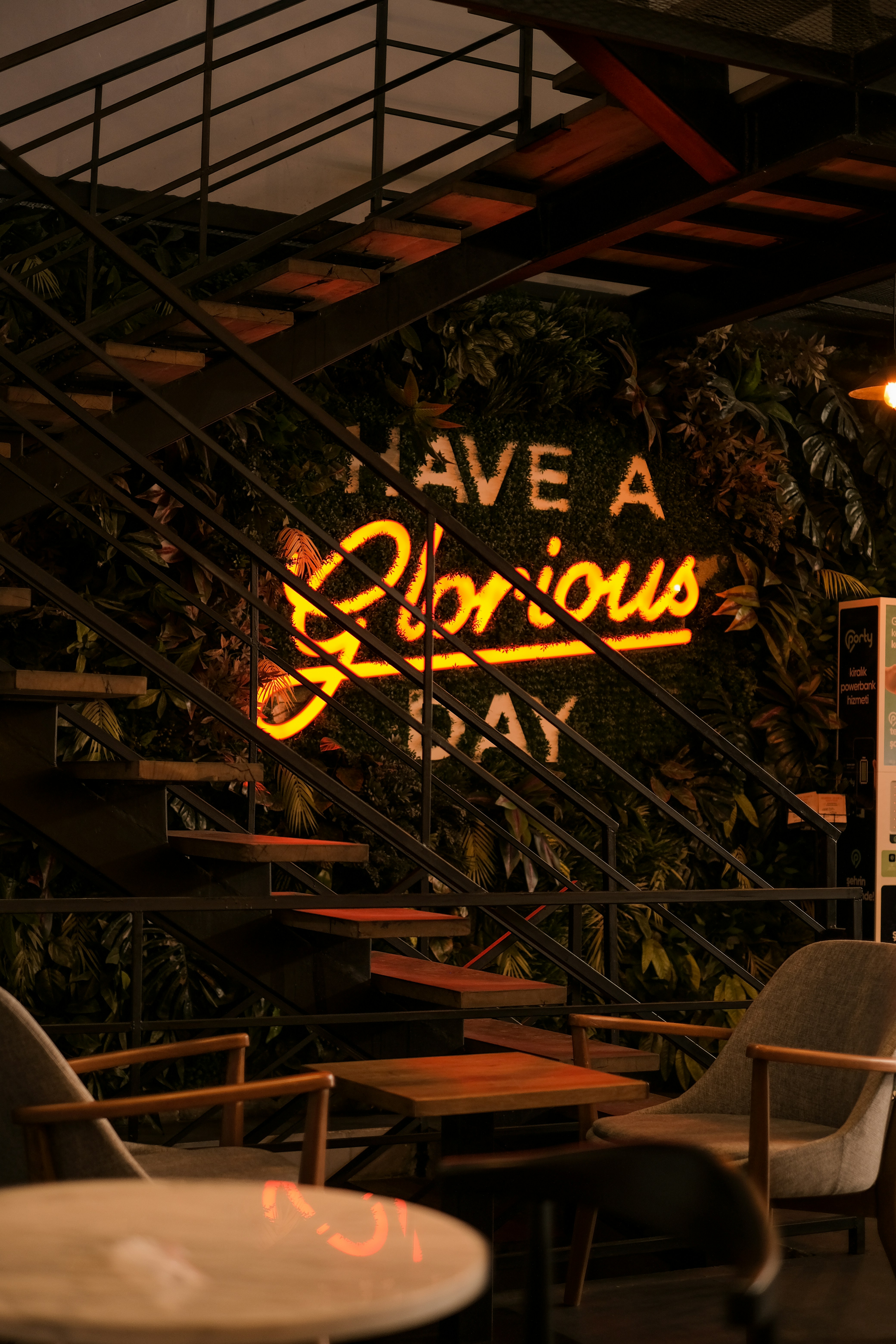 A restaurant with stairs and a sign that says i have a glorious day ...