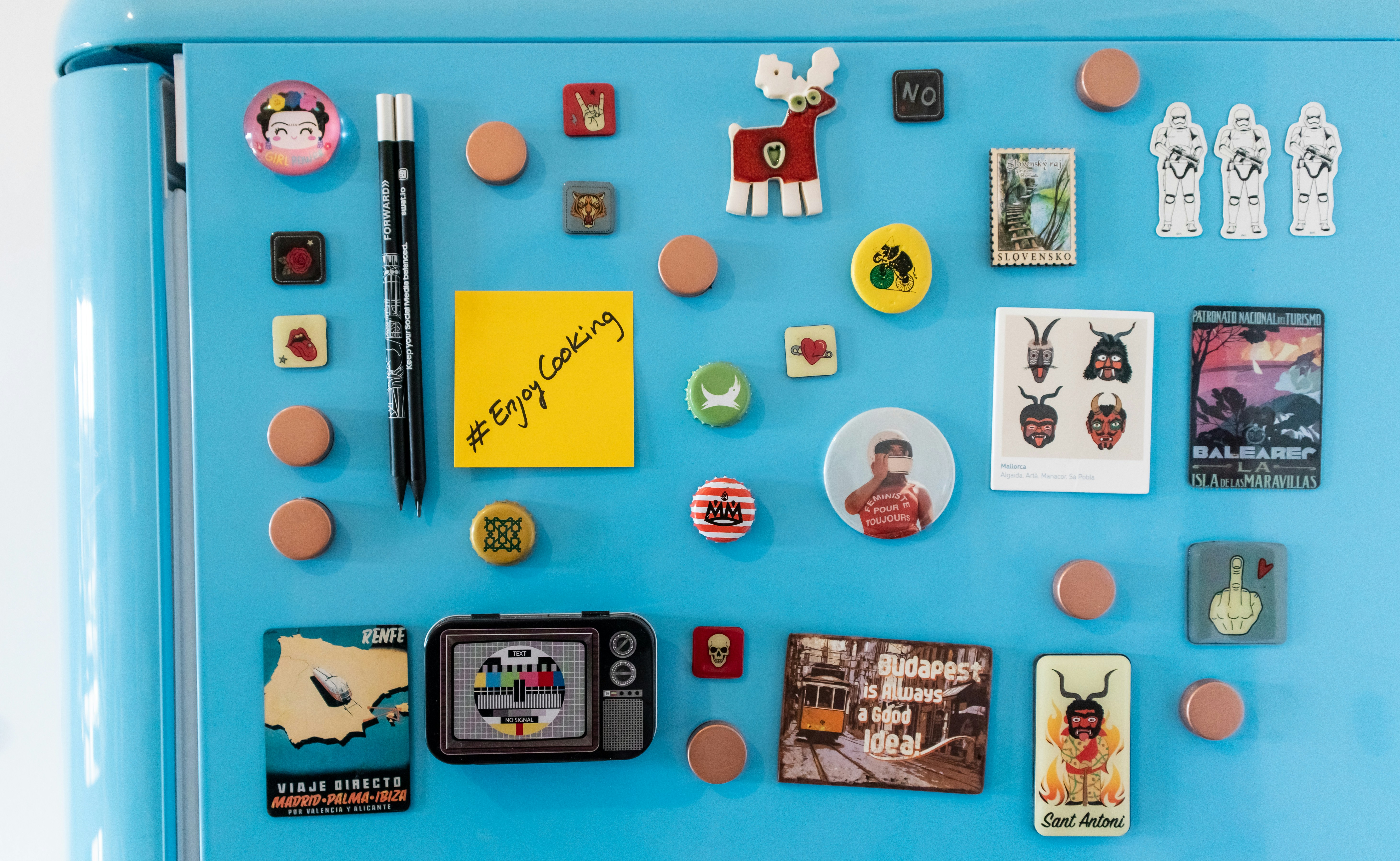 A blue refrigerator with magnets and pictures on it photo – Free Post ...