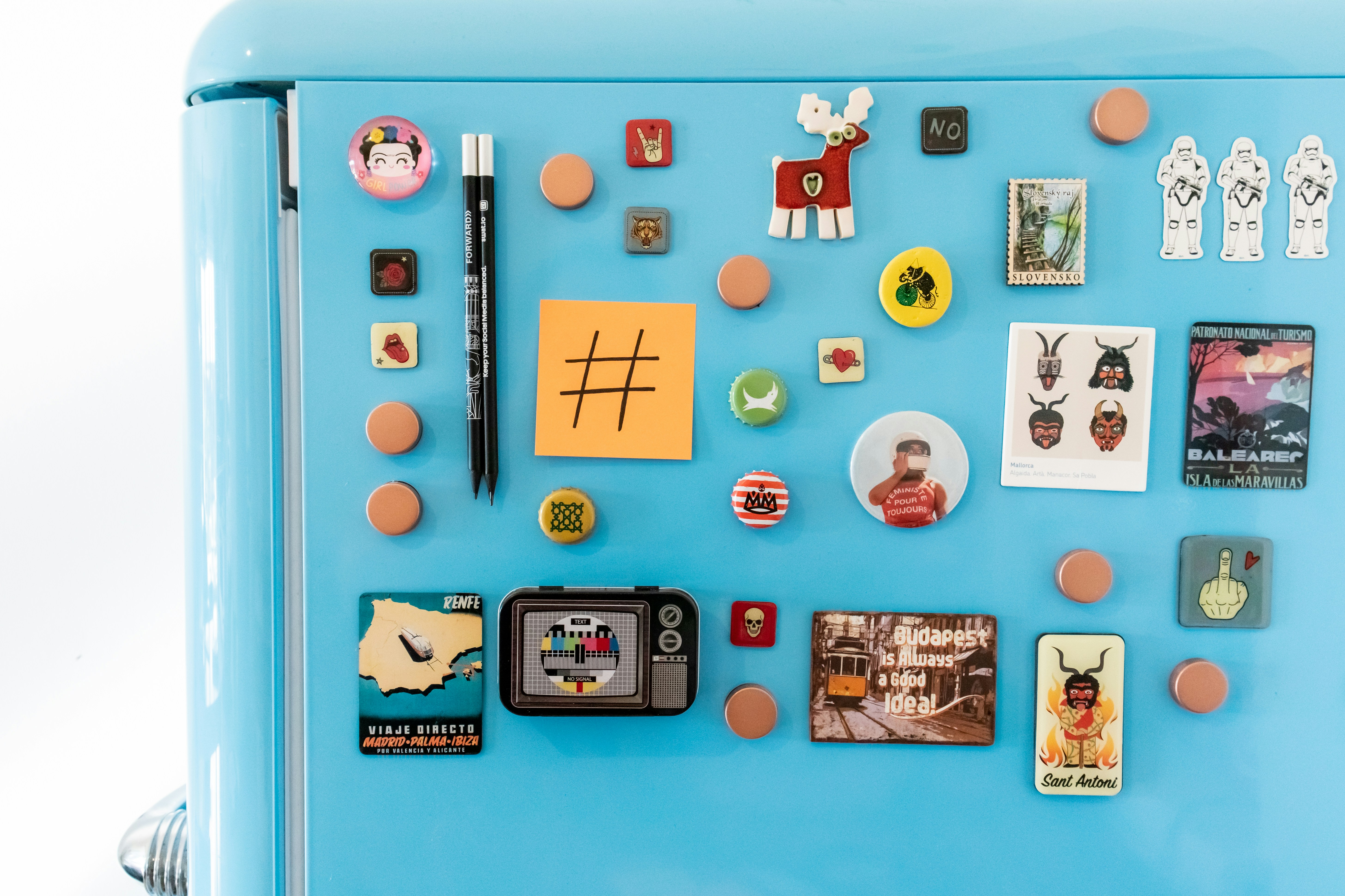 A blue refrigerator with magnets and pictures on it photo – Free Art ...