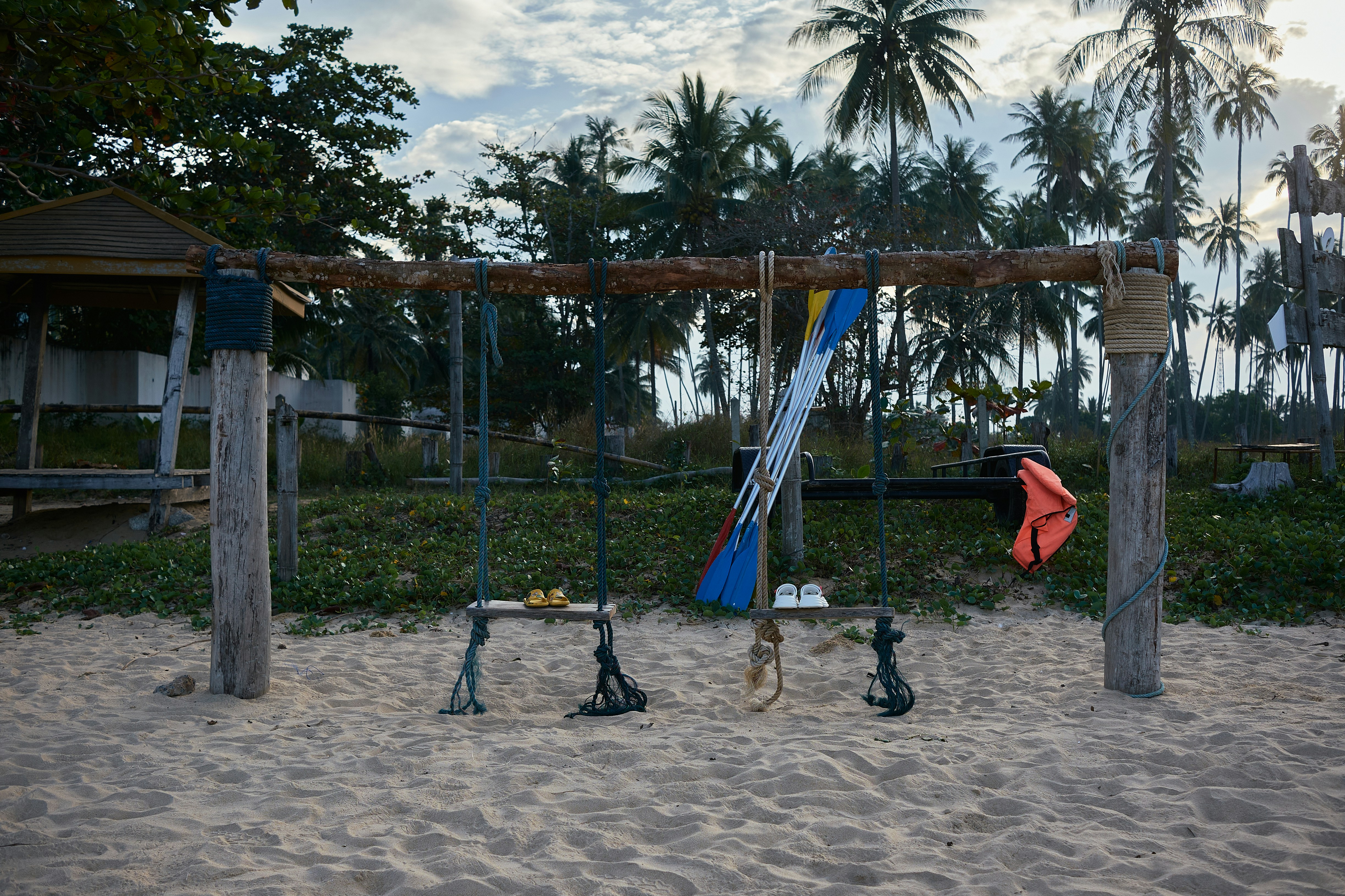 a playground with a swing set and climbing ropes