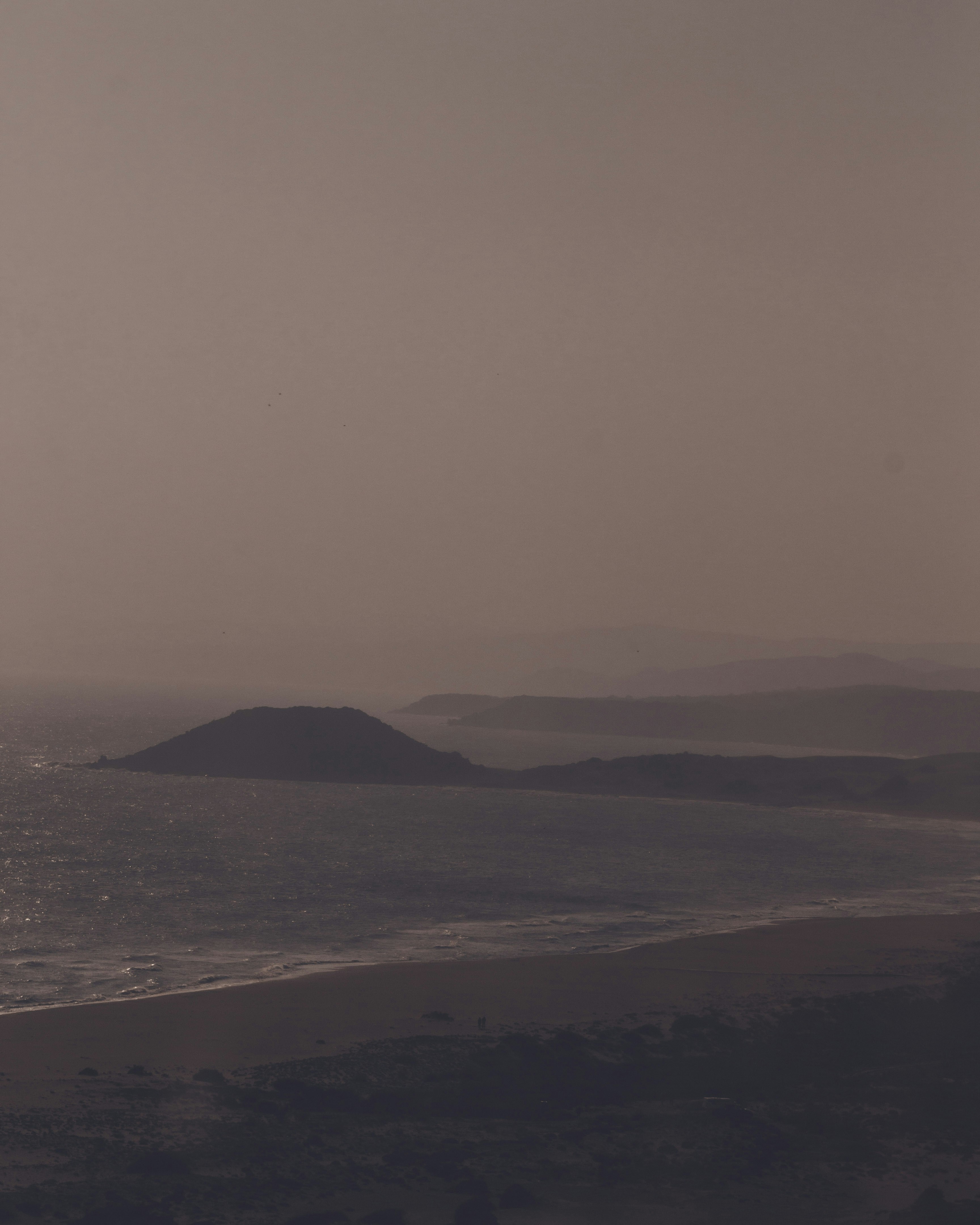 Dusk Silhouette: A Lone Island Halts the Horizon
