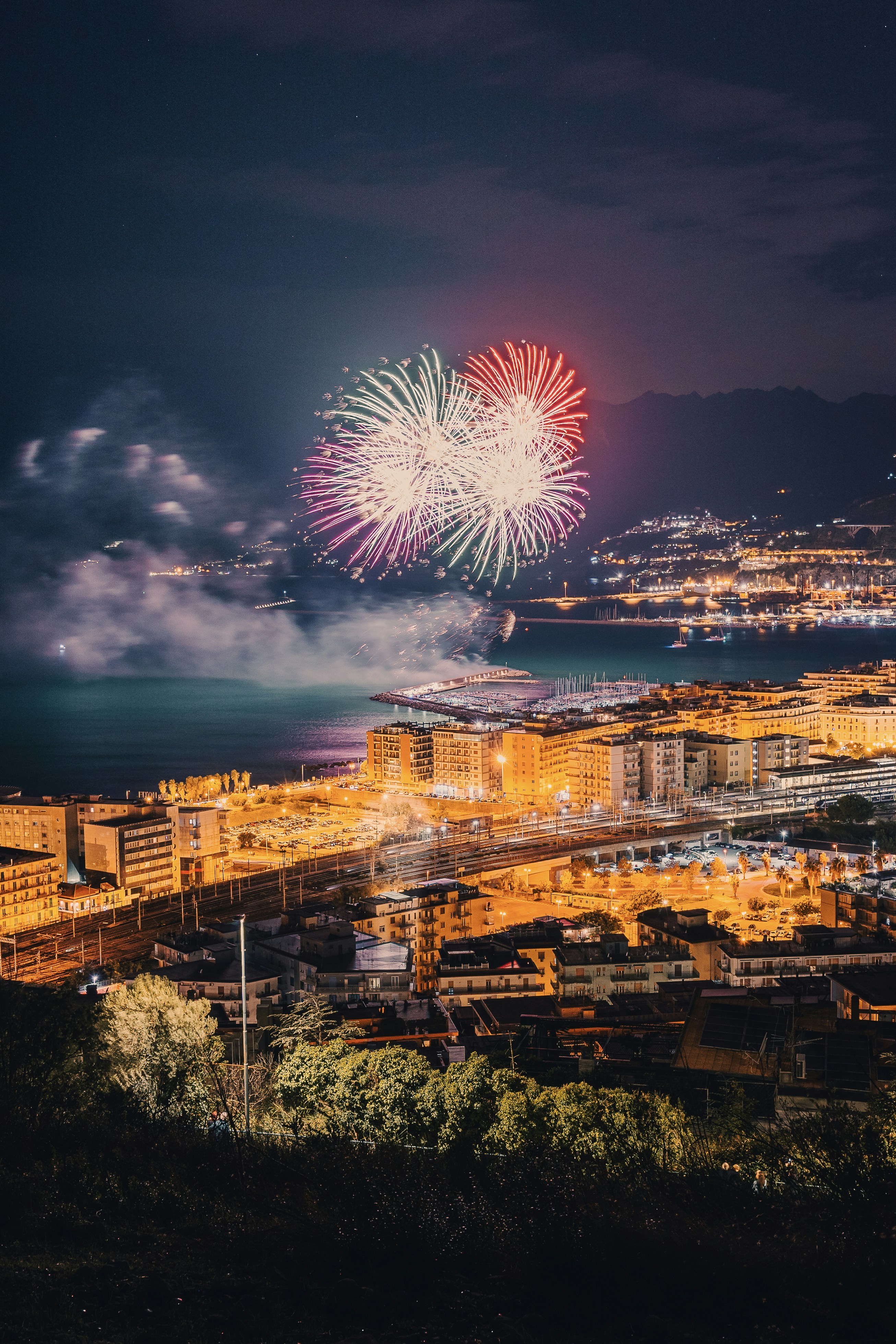 A fireworks display over a city at night photo – Free Salerno Image on ...