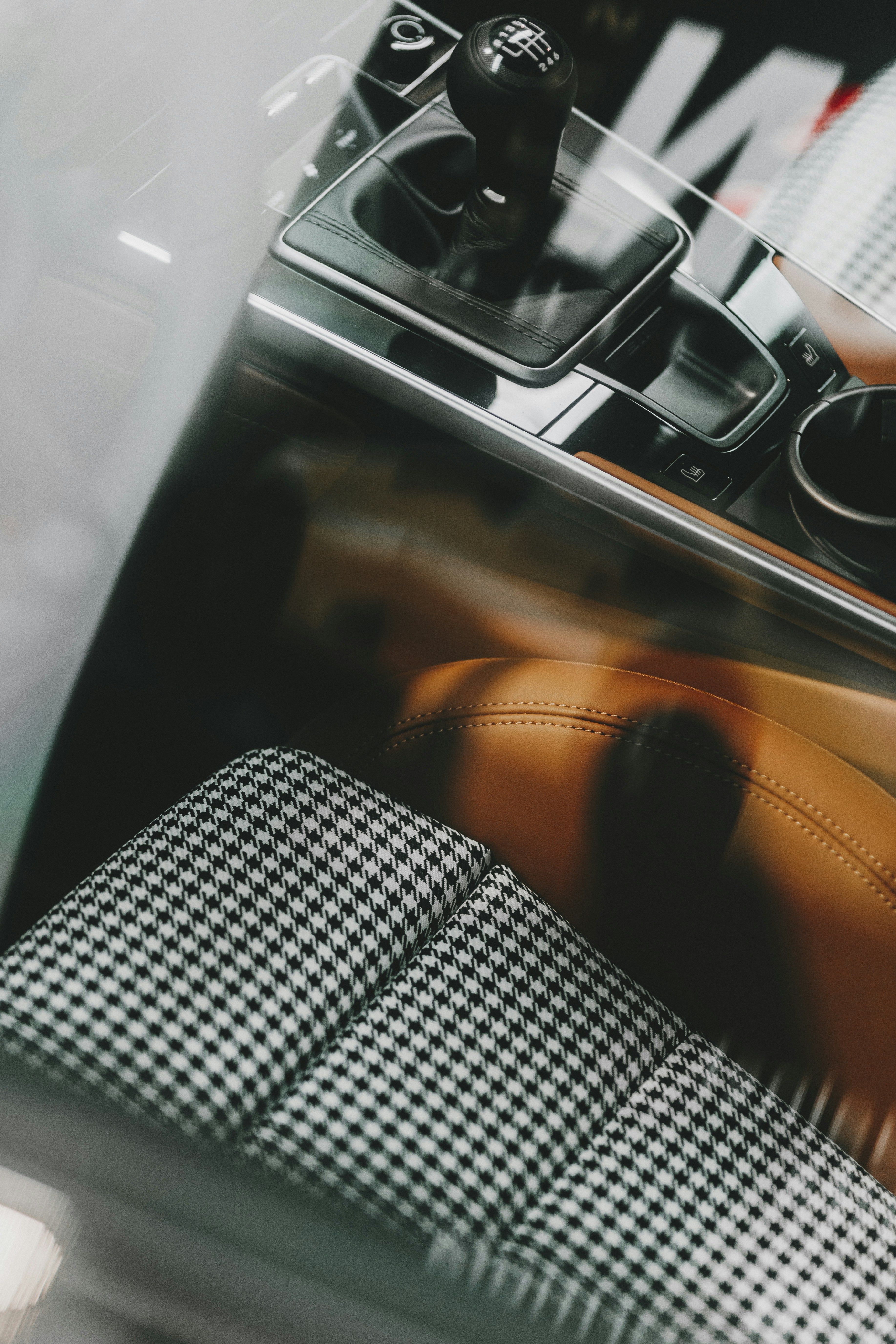 Manual Gearshift in a Luxe Cockpit: Houndstooth and Brown Leather