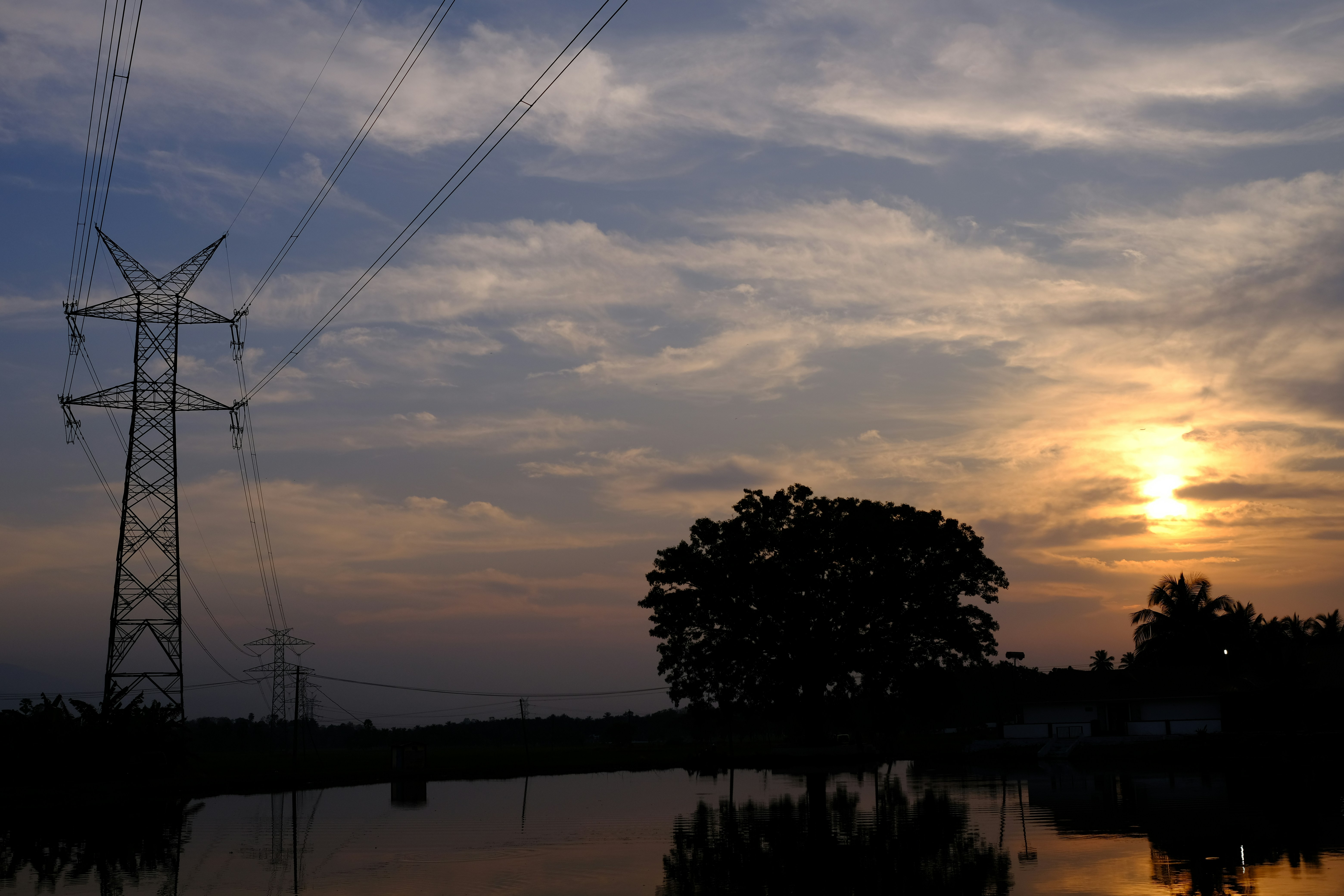 Sunset Between Steel and Shade: A Quiet Riverside Silhouette