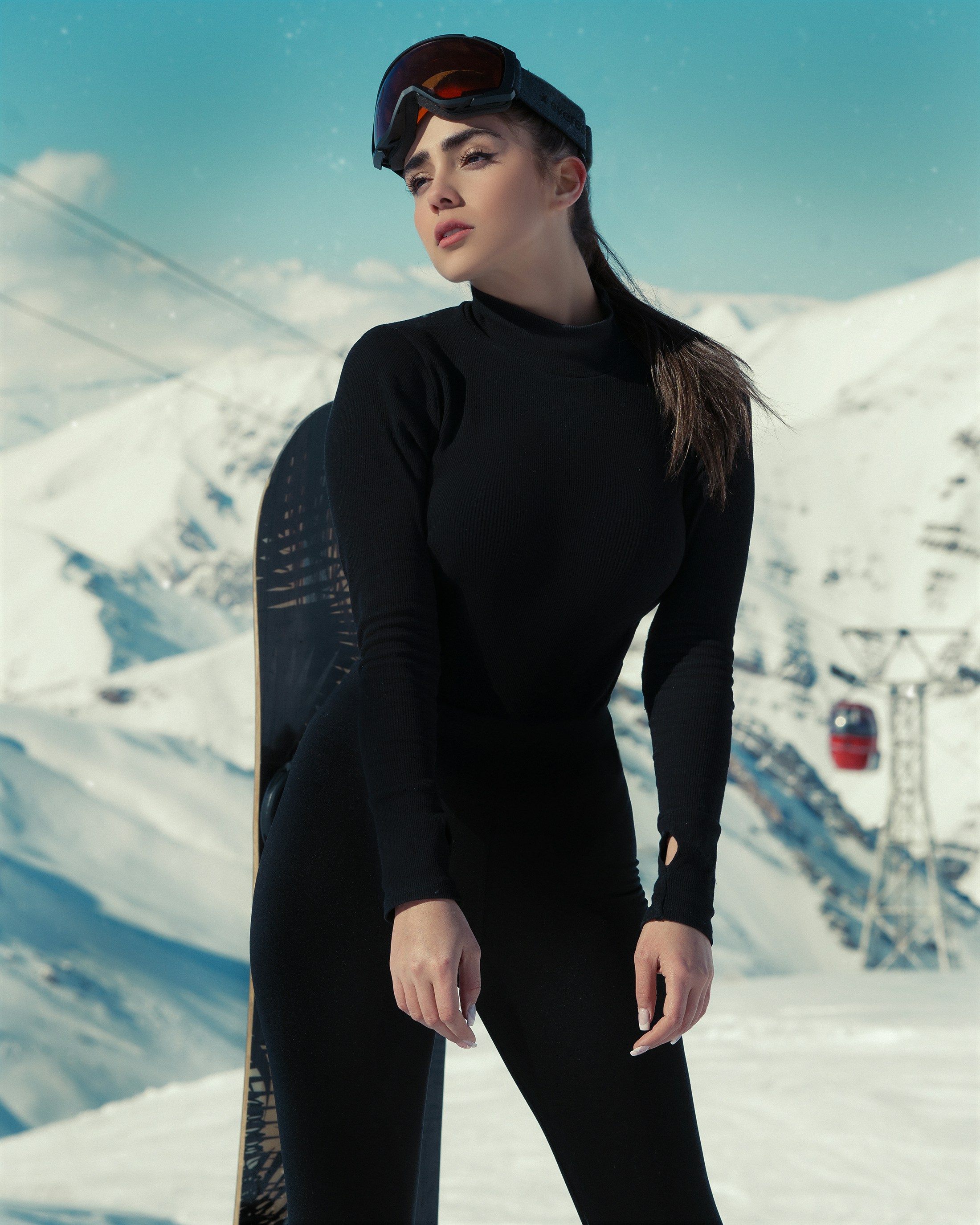 Snowbound Gaze: A Black-Suited Snowboarder Amid Alpine Silence