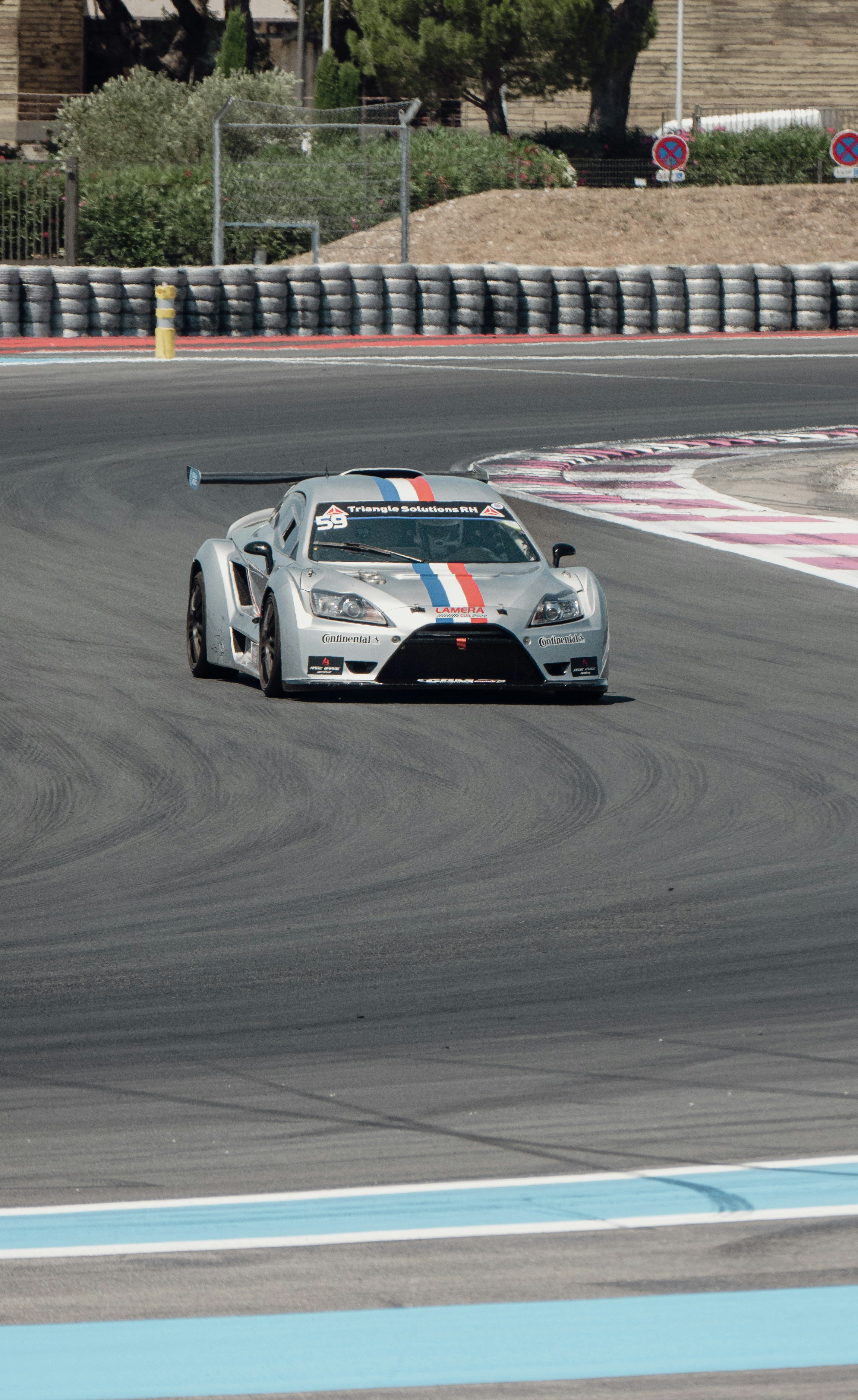 White GT Racer Slices the Apex on a Sunlit Turn