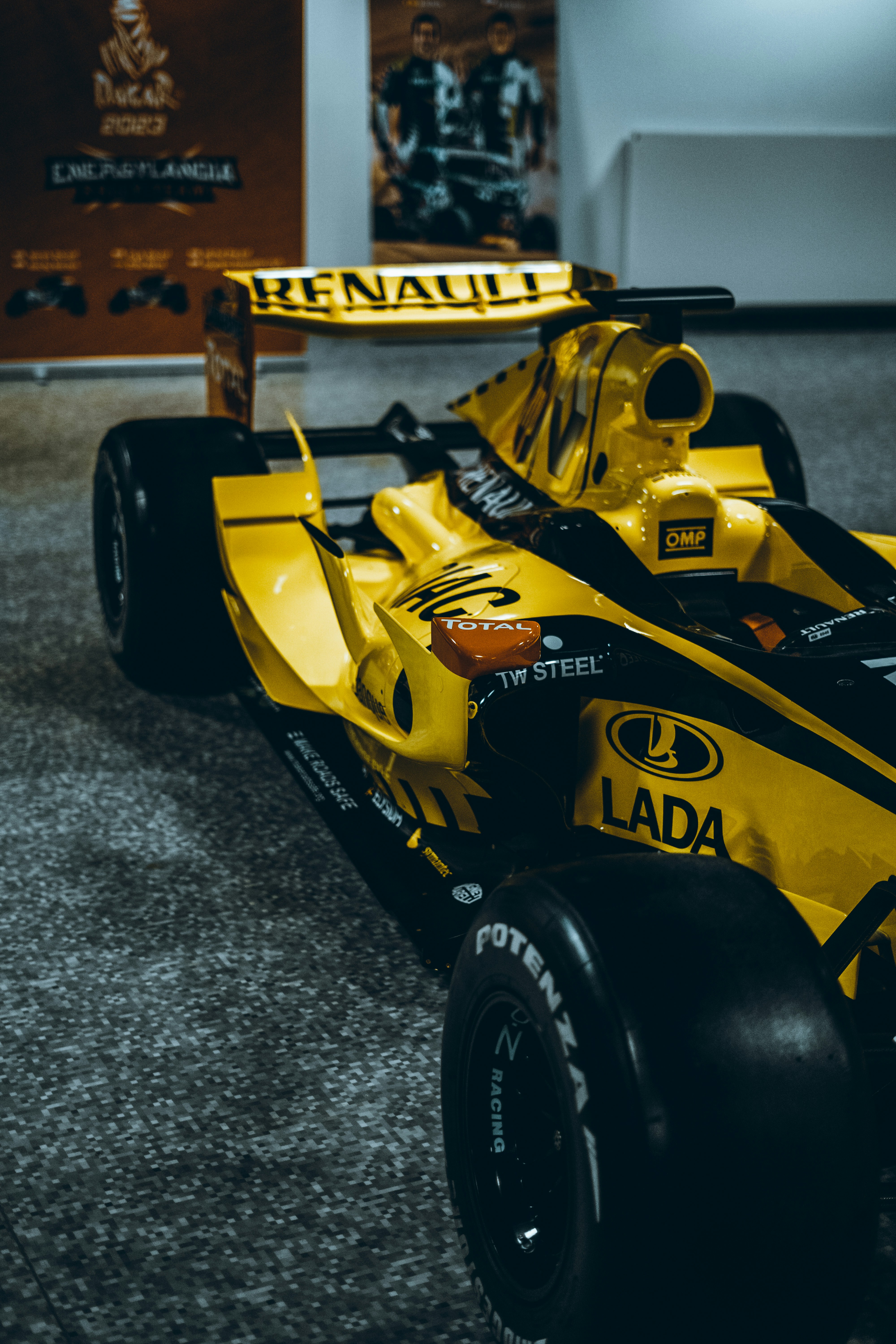 a yellow race car on display in a museum