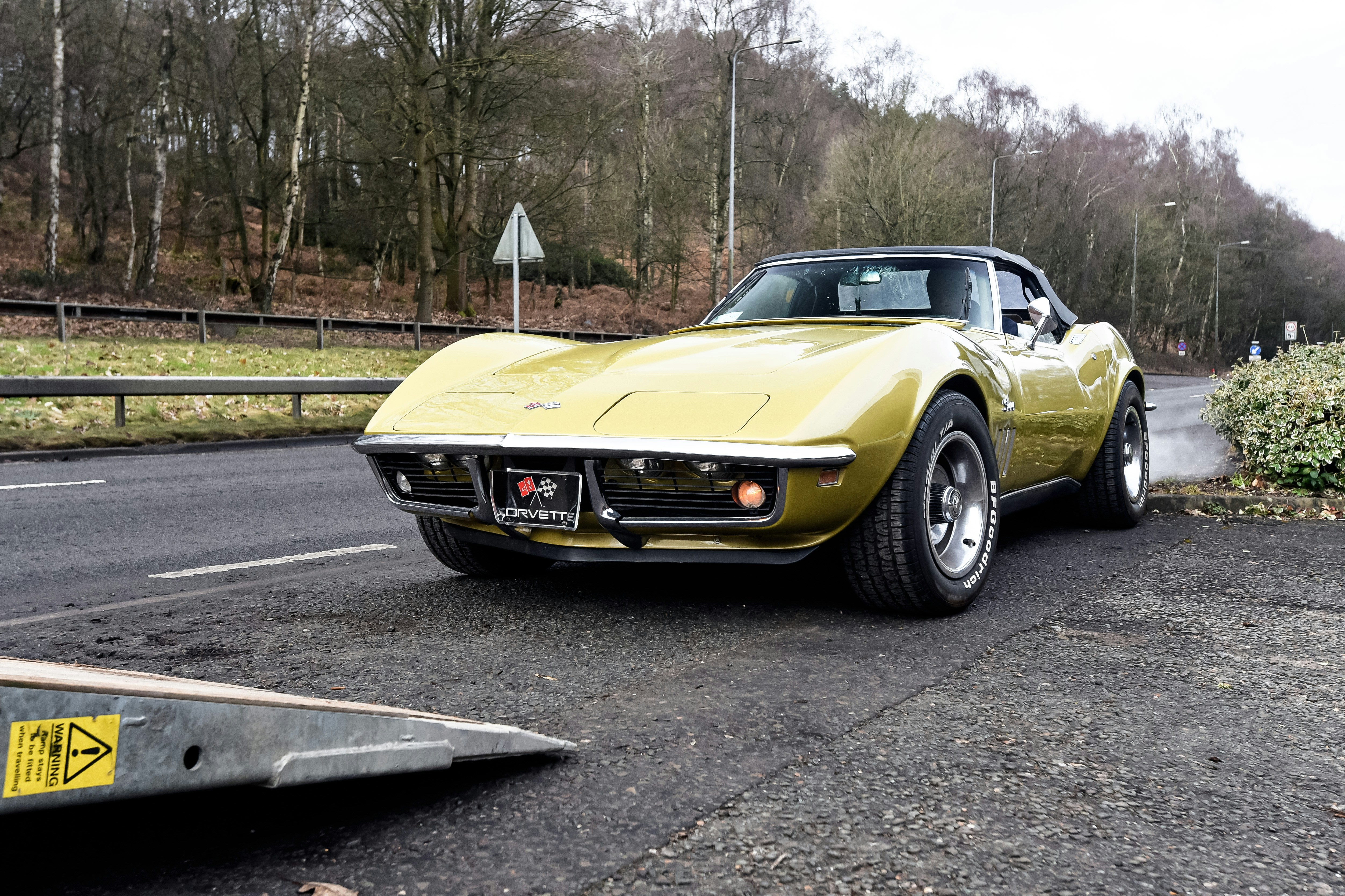 A yellow sports car is parked on the side of the road photo – Free Dave ...