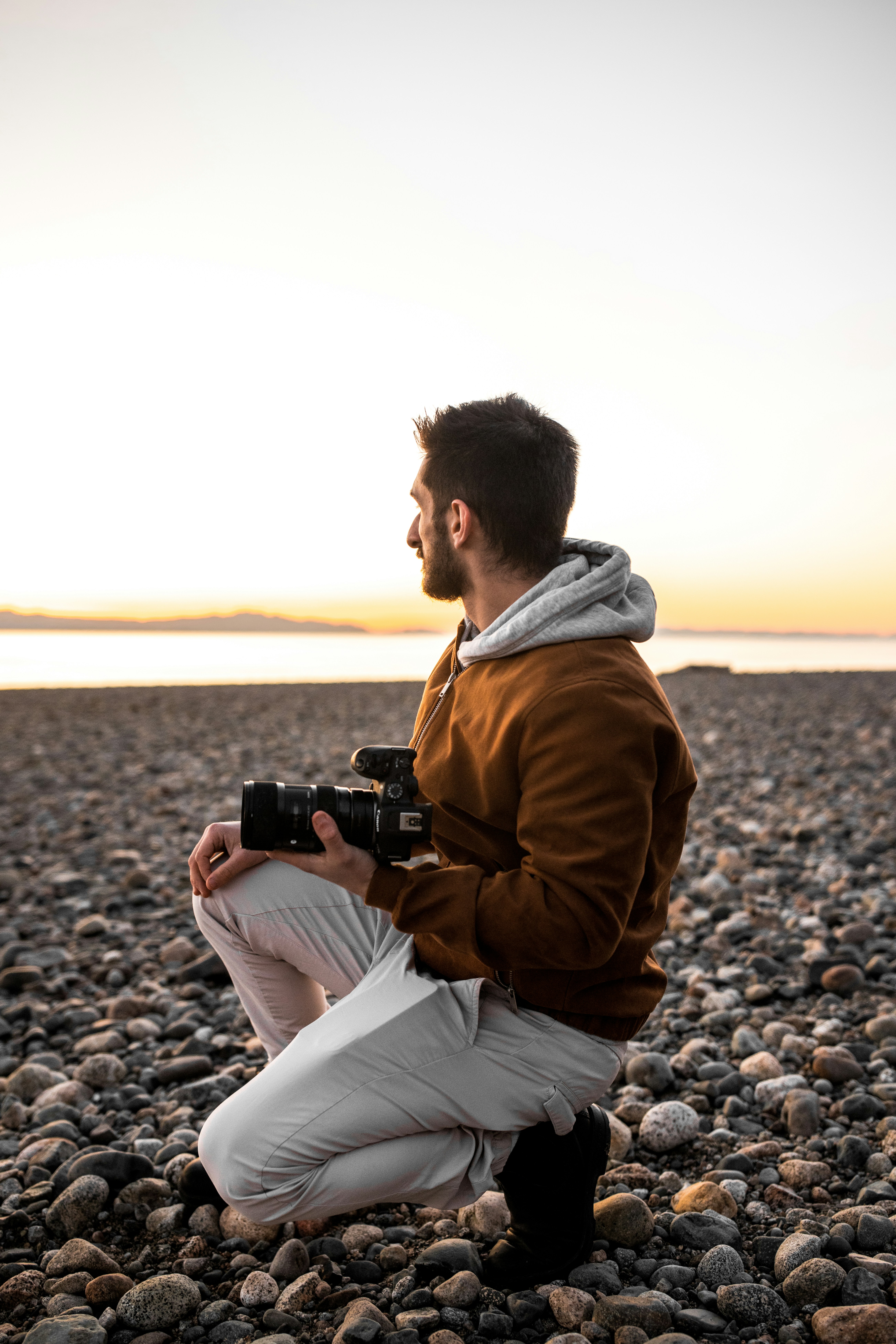 Pebble Beach Quiet Capture: A kneeling photographer frames the sunset