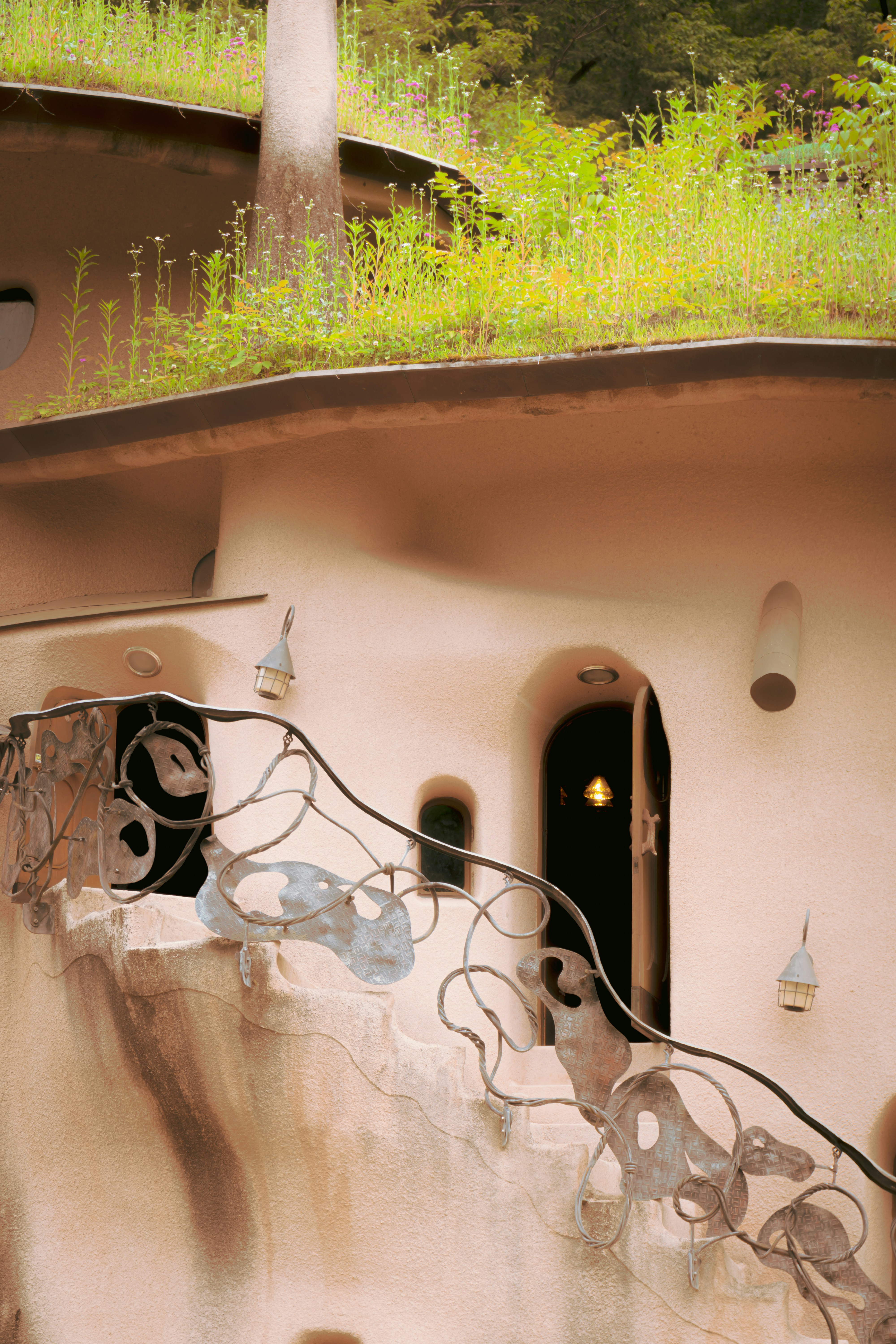 Archways of Ember: A Garden-Topped Façade and a Warm Doorway