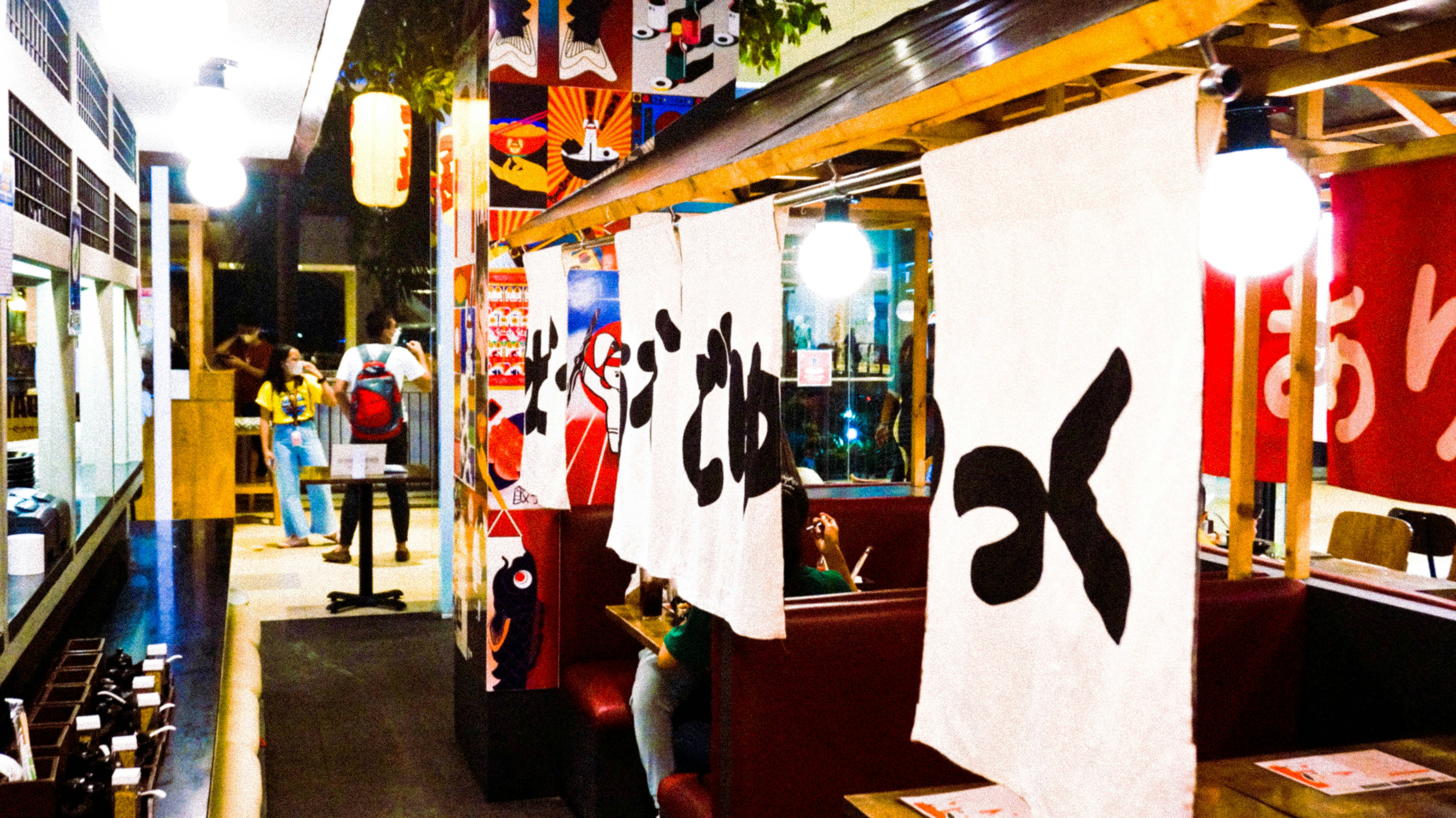 Lantern-lit Alleyway: A Sushi Bar Corridor Framed by Japanese Noren