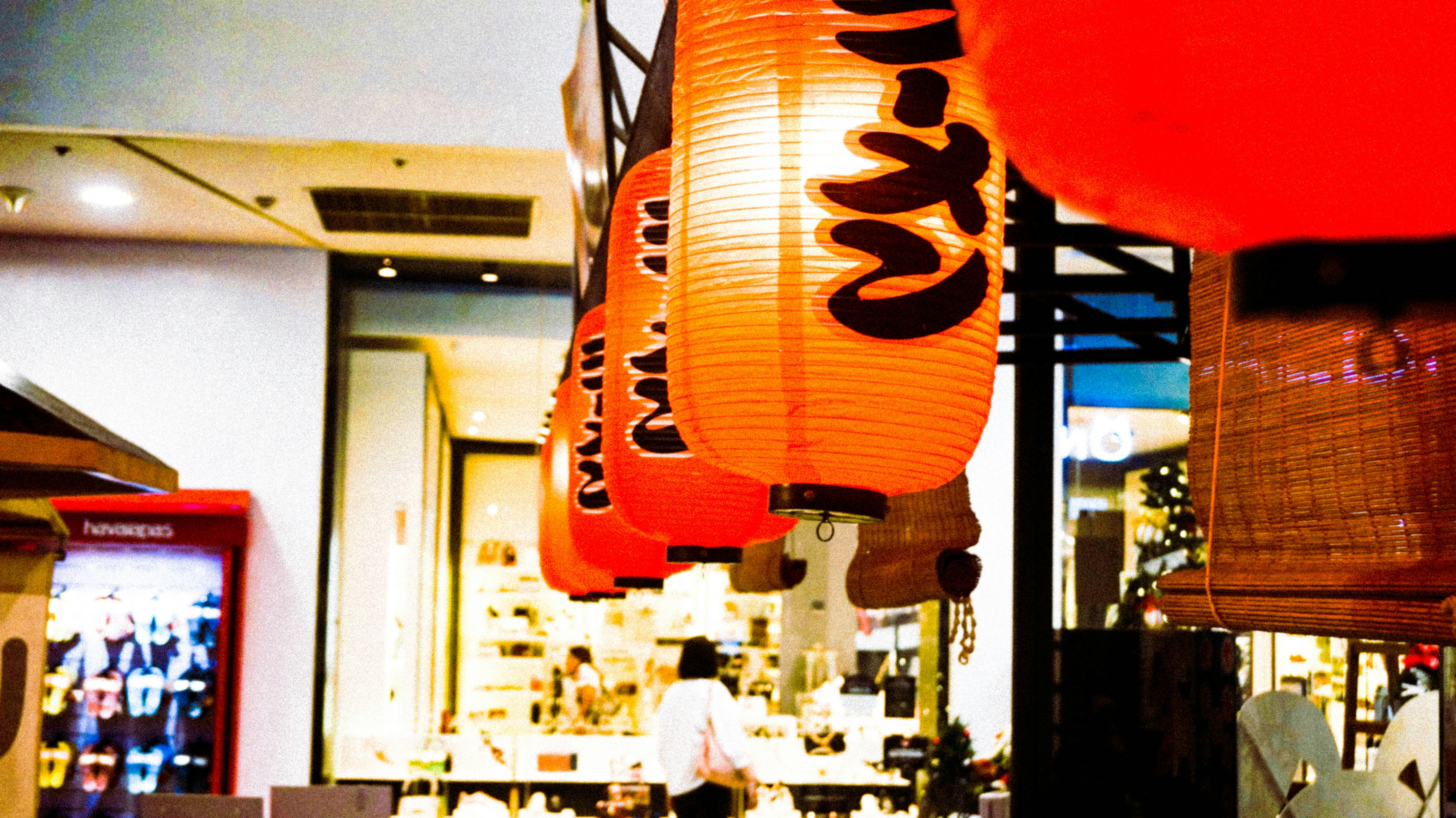 Amber Lantern Corridor Inside a Busy Japanese Eatery