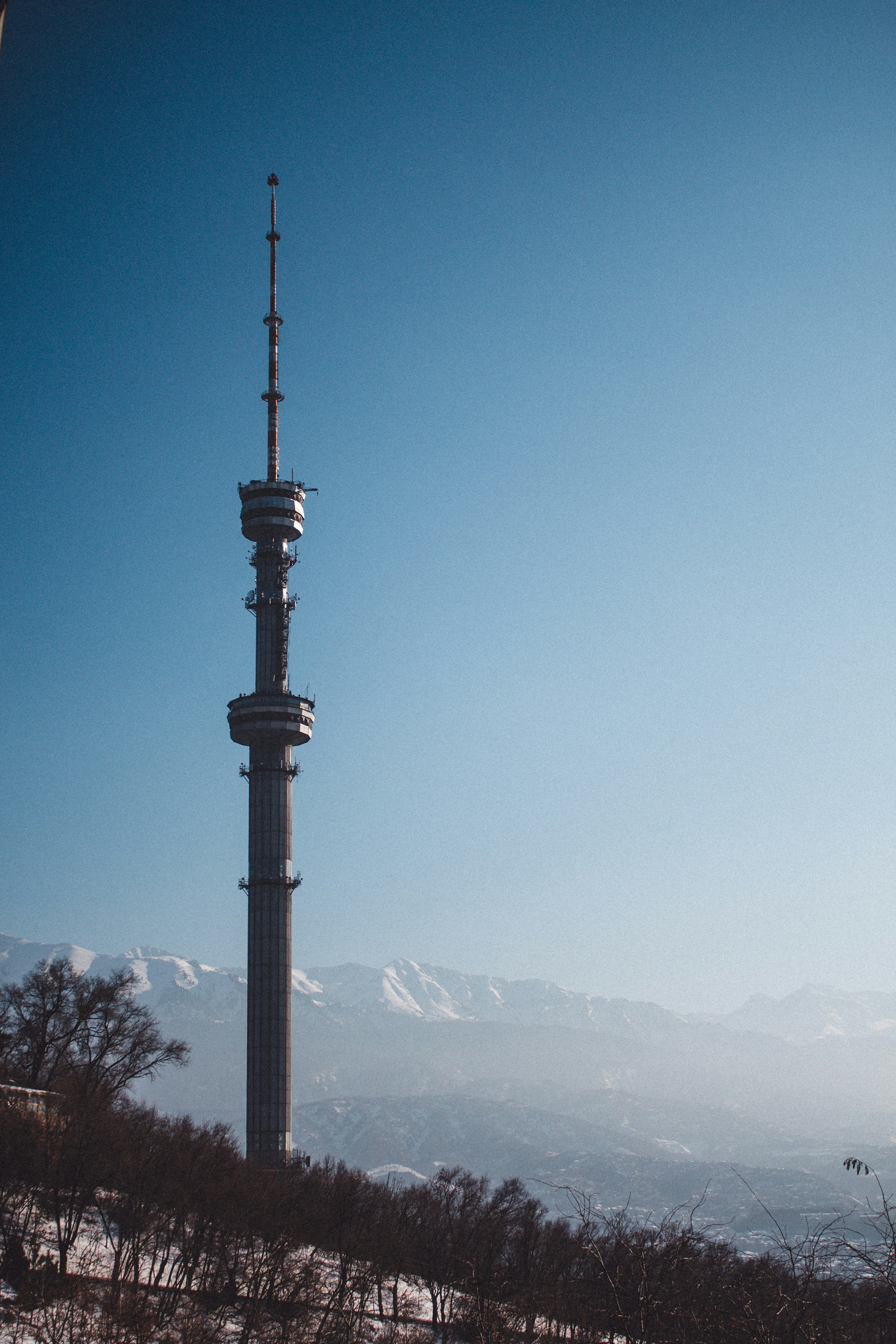 Alpine Sentinel: The Lone Tower Above Snow-Dusted Valleys