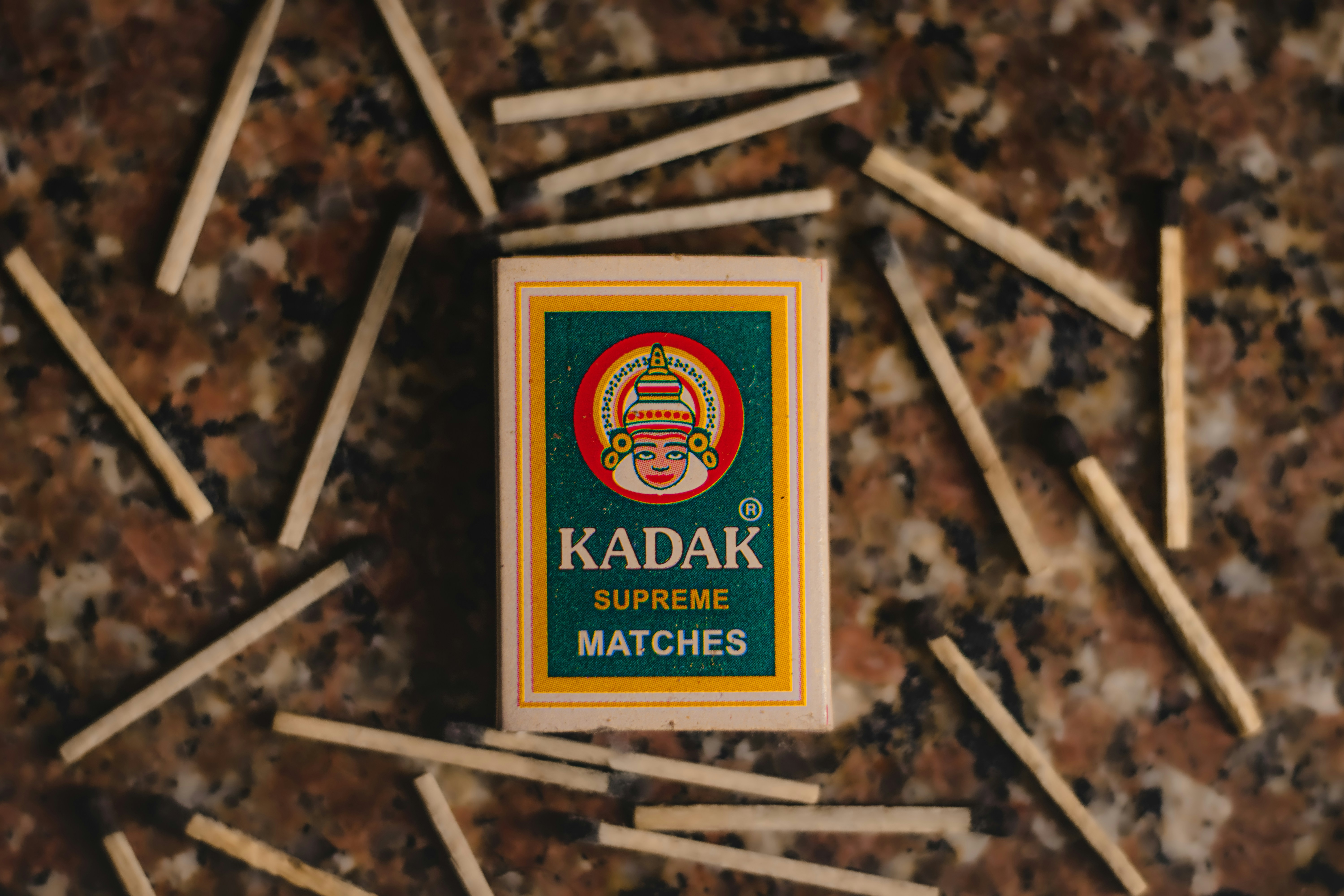 A matchbox of kadak matches on a marble surface photo – Free Logo Image ...