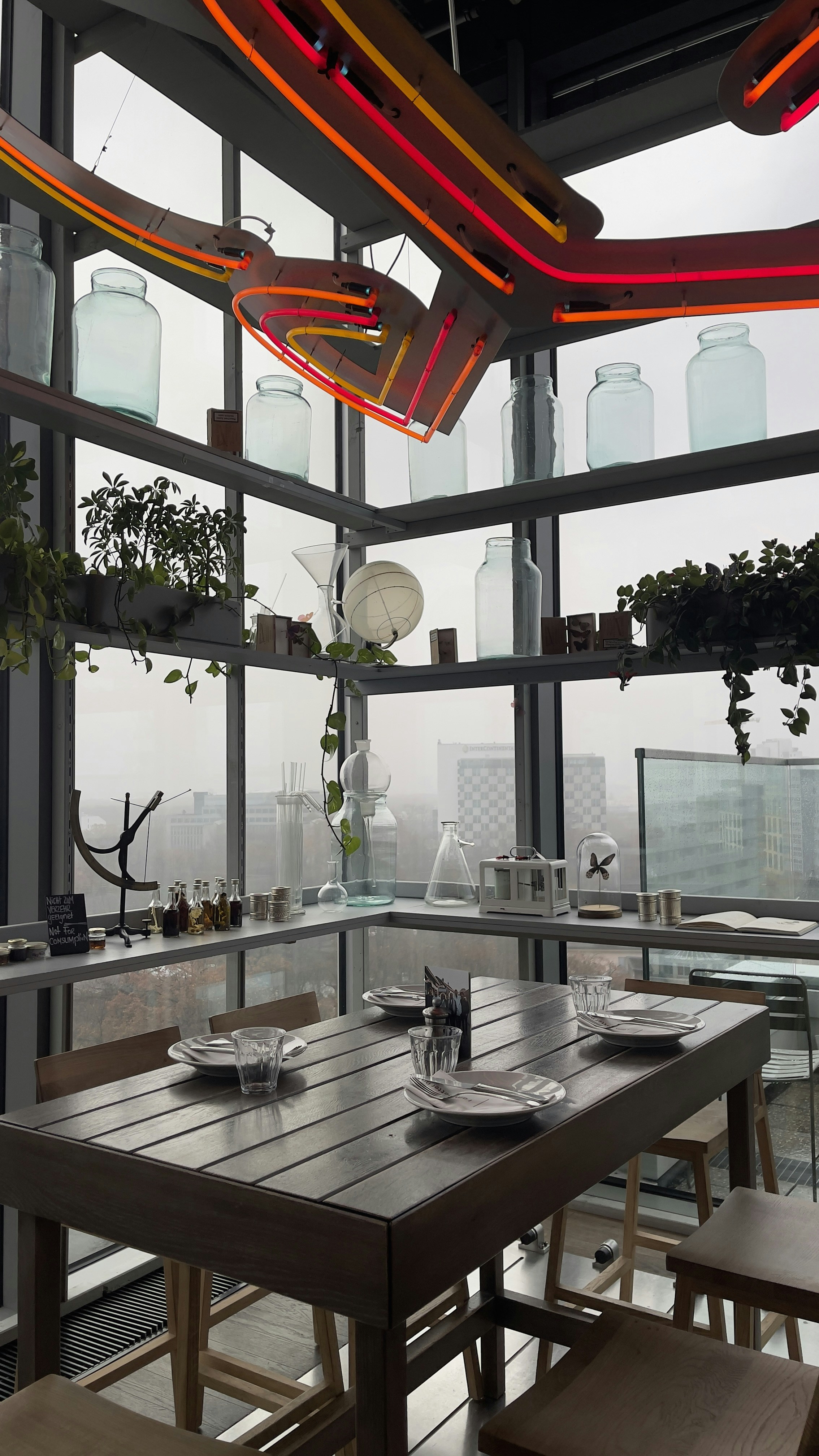 Neon Arches Over a Glass-Walled Rooftop Bistro