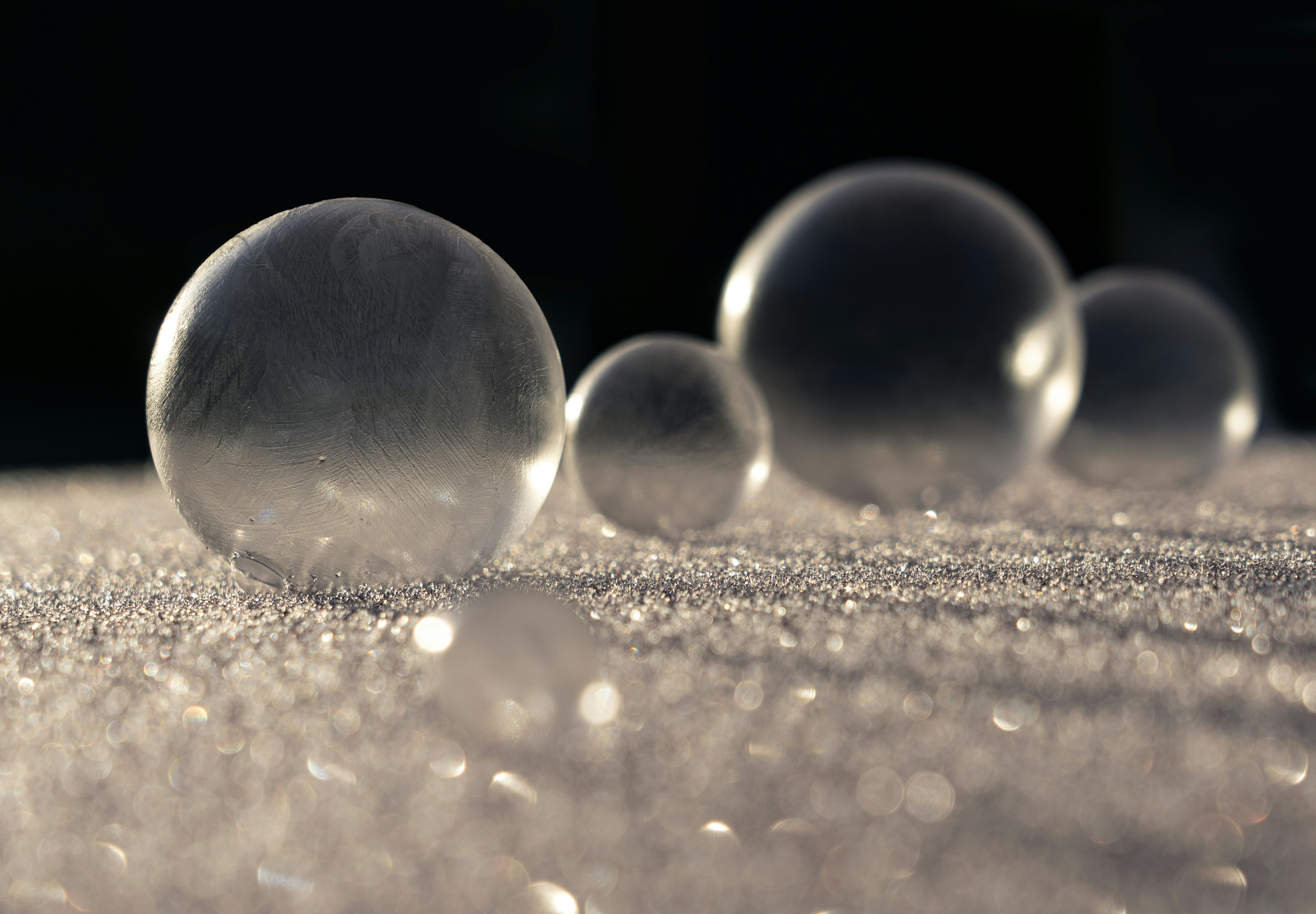 Glassy Orbs on a Glittering Frosted Surface
