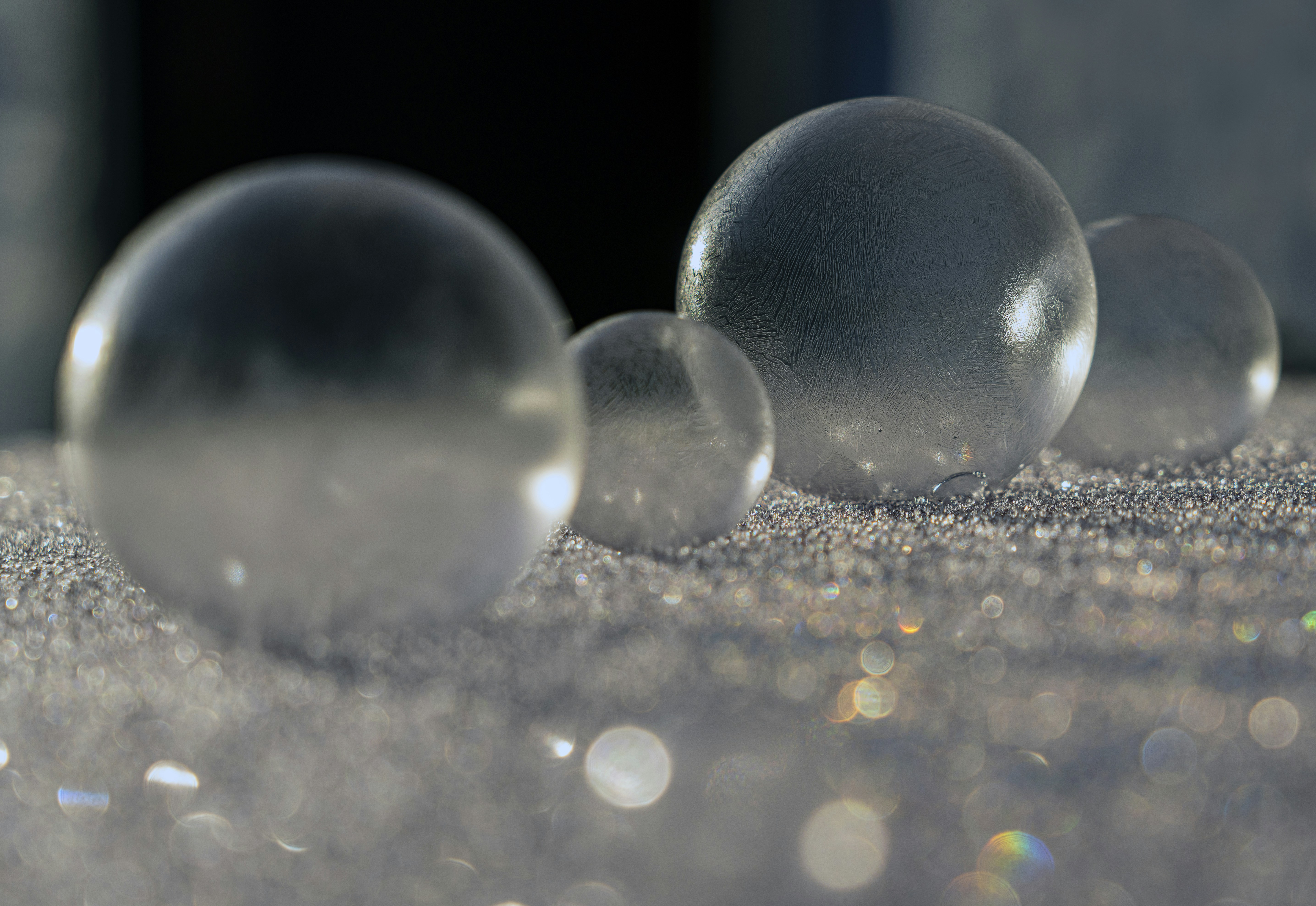 Echoes of Light: Glass Marbles on Frosted Sand