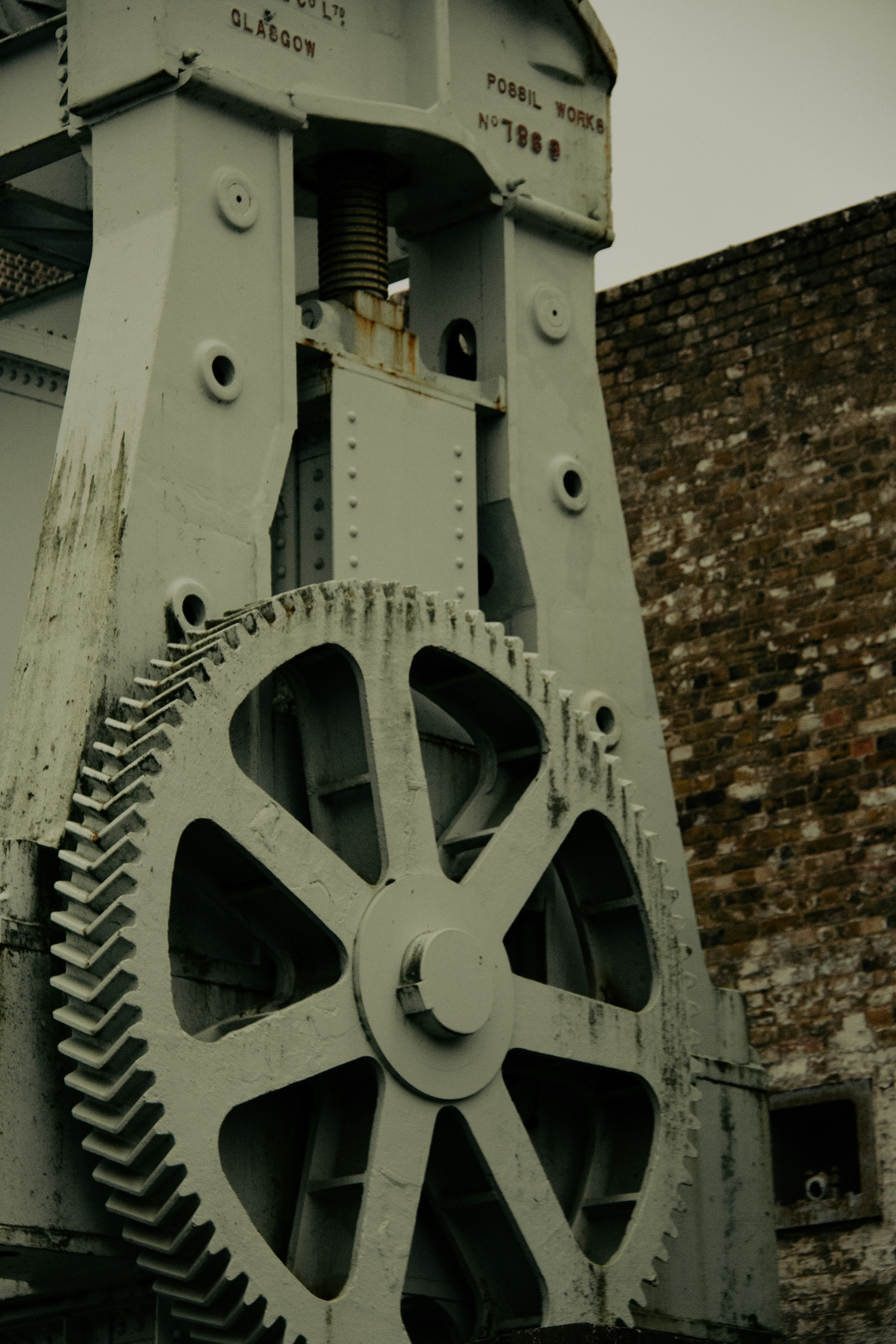a close up of a machine with a brick wall in the background