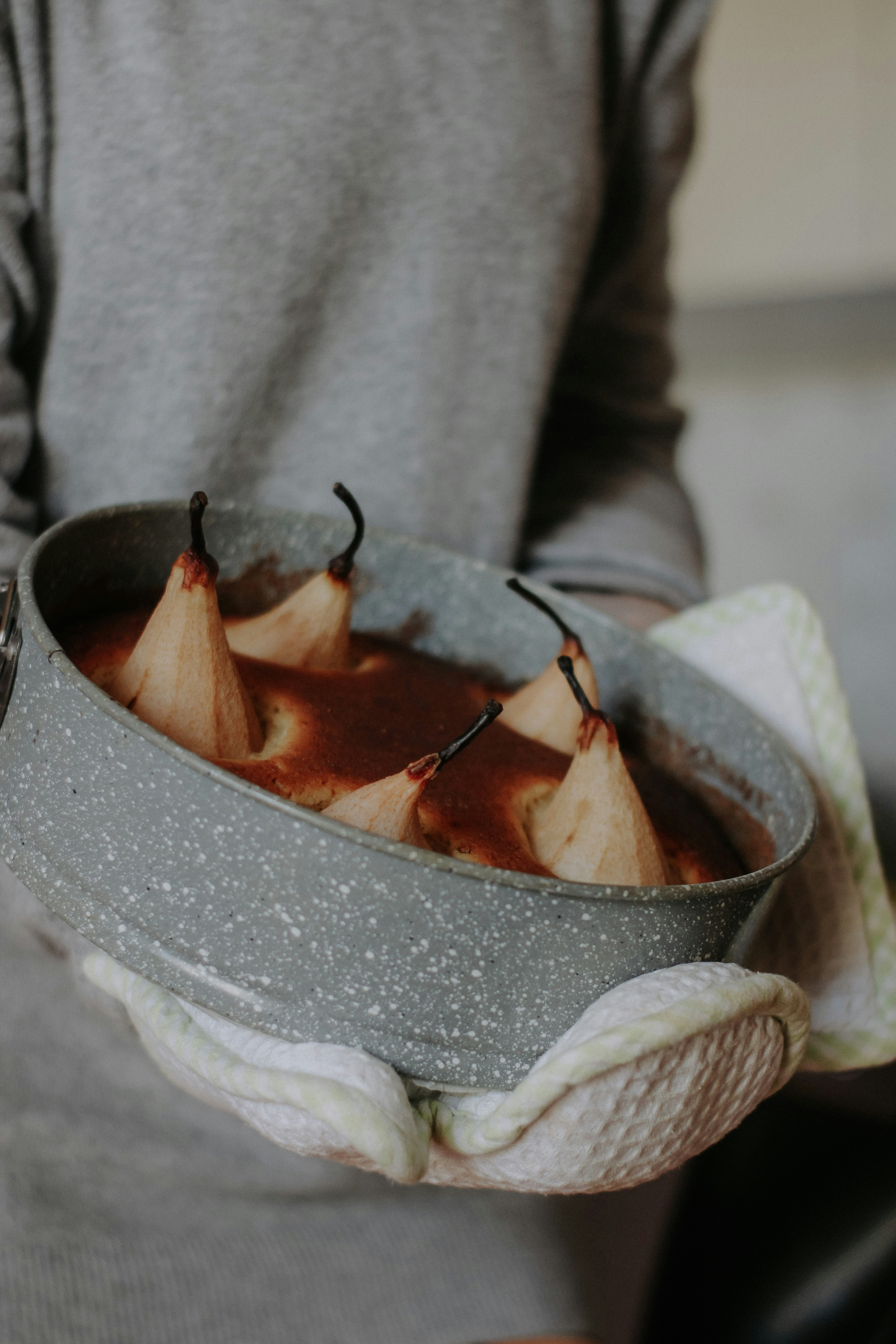 a person holding a metal bowl filled with food