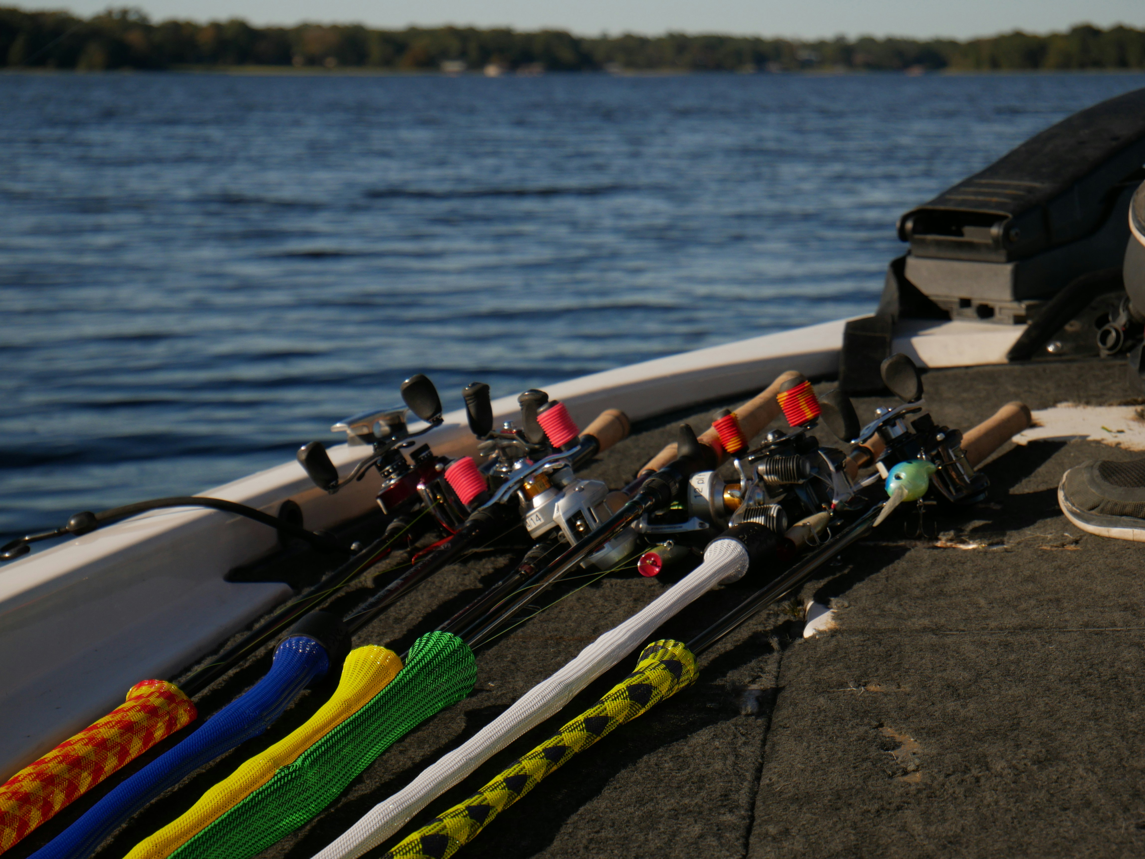 A row of fishing rods sitting on top of a boat photo – Free Fresh water ...