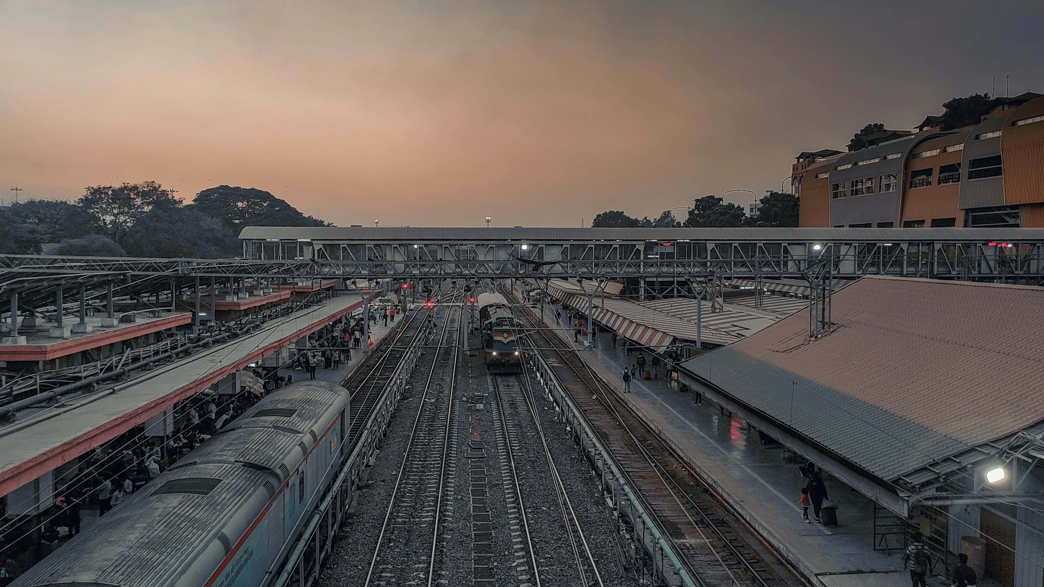A train station with multiple trains on the tracks photo – Free Pune ...