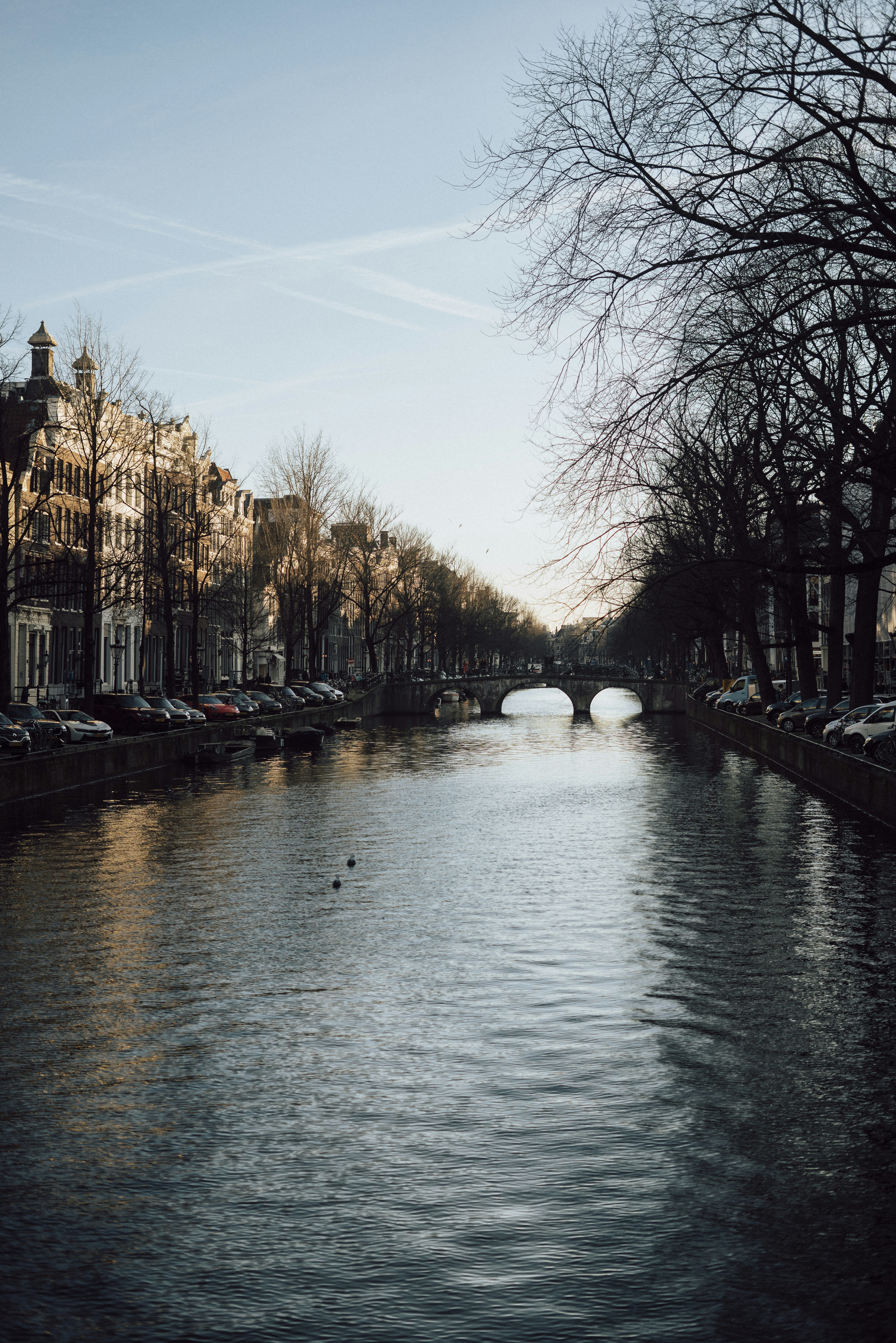 a river running through a city next to tall buildings