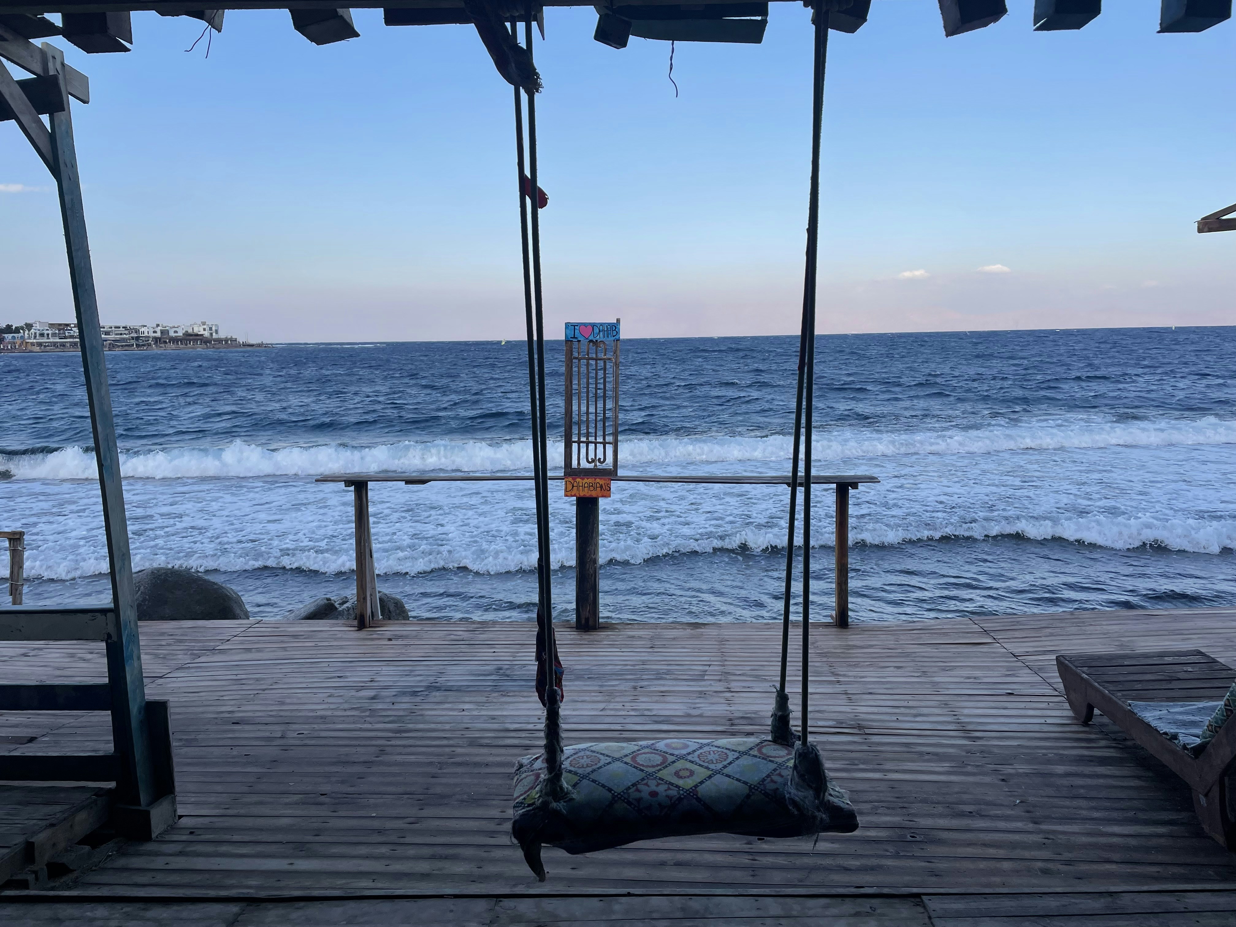 Seaside Swing: A Quiet Moment on the Wooden Deck