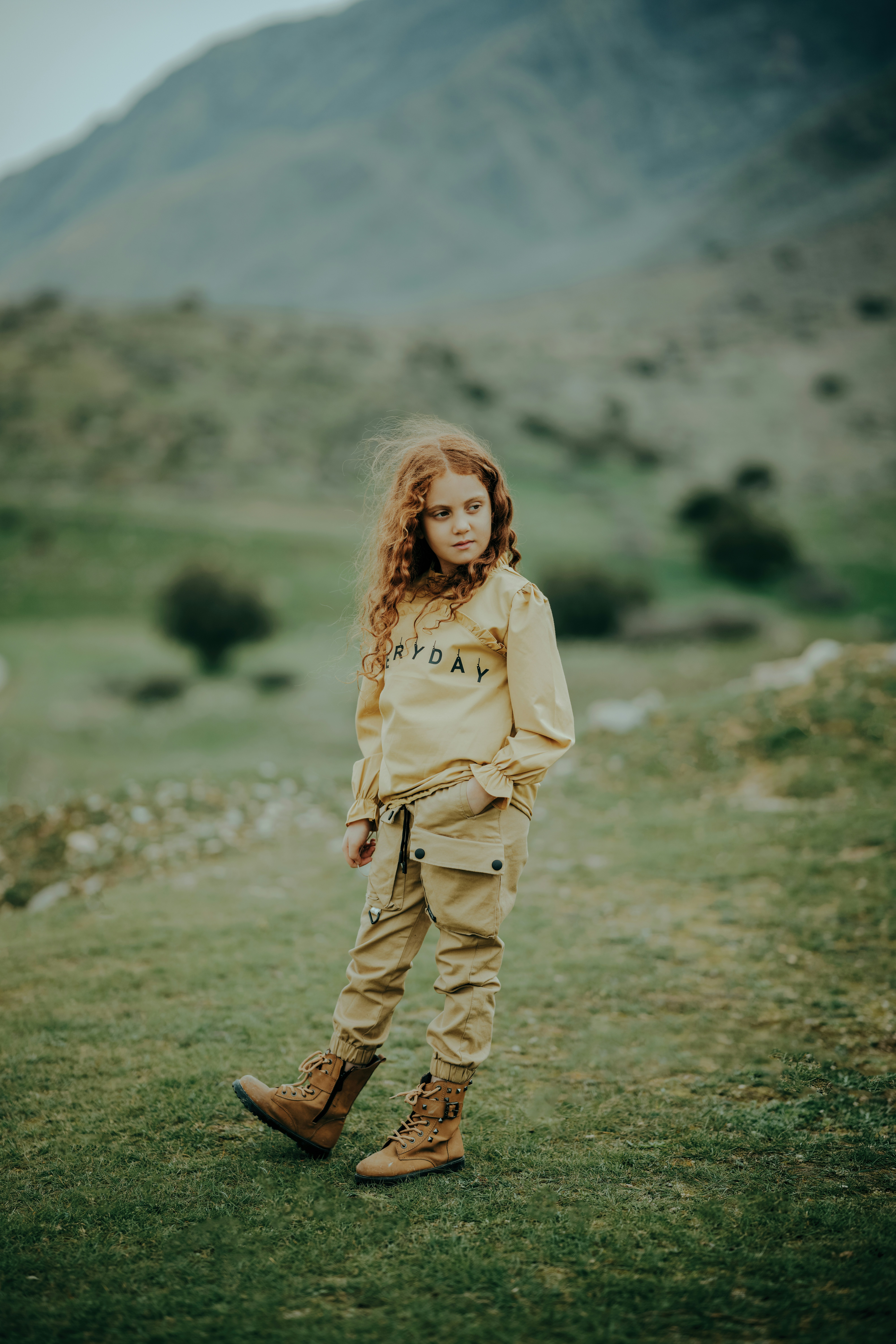 Golden Hour Portrait in a Mountain Meadow: A Girl in Taupe Boots