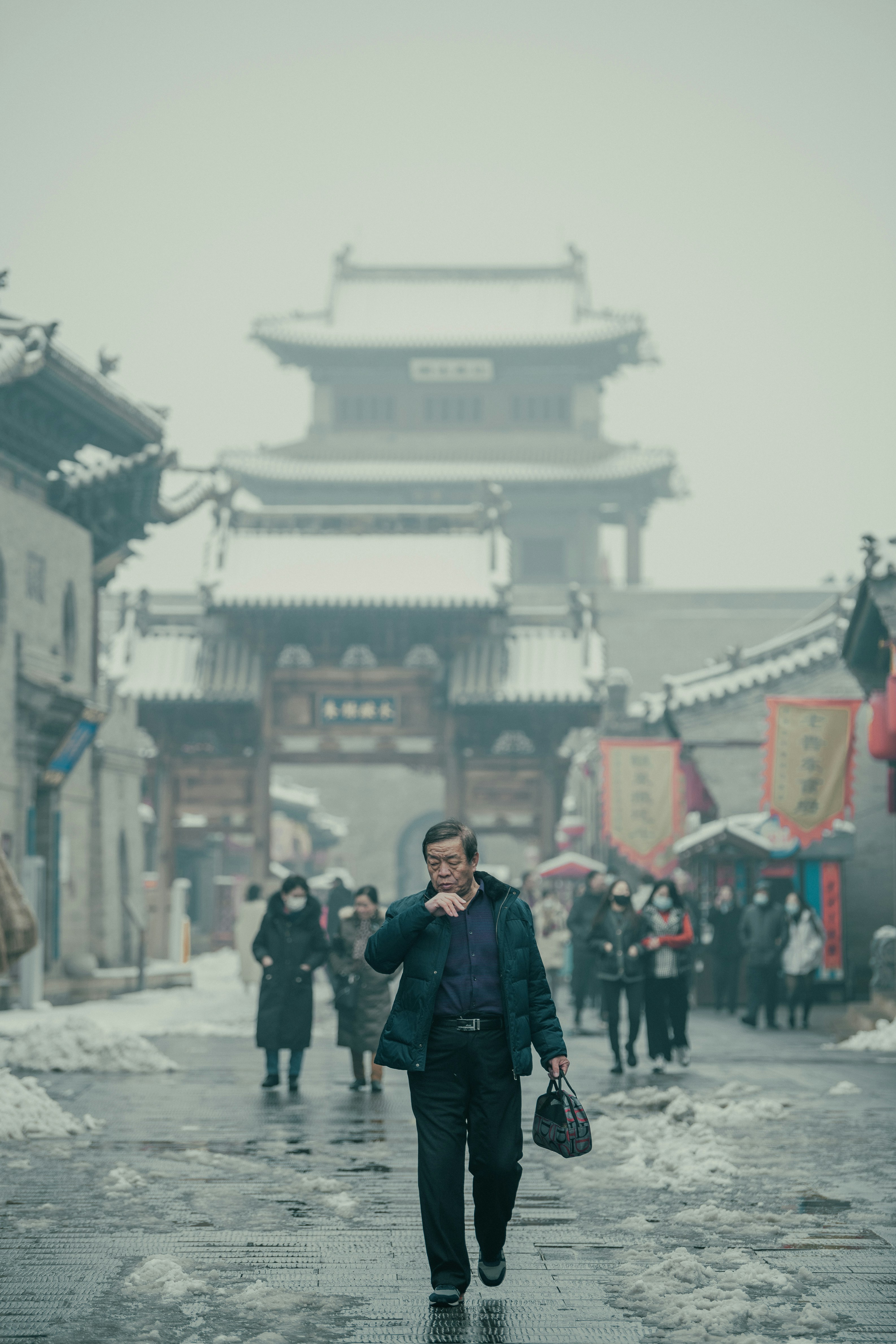 Snow-dusted Lantern Street Under a Timeless Chinese Gate