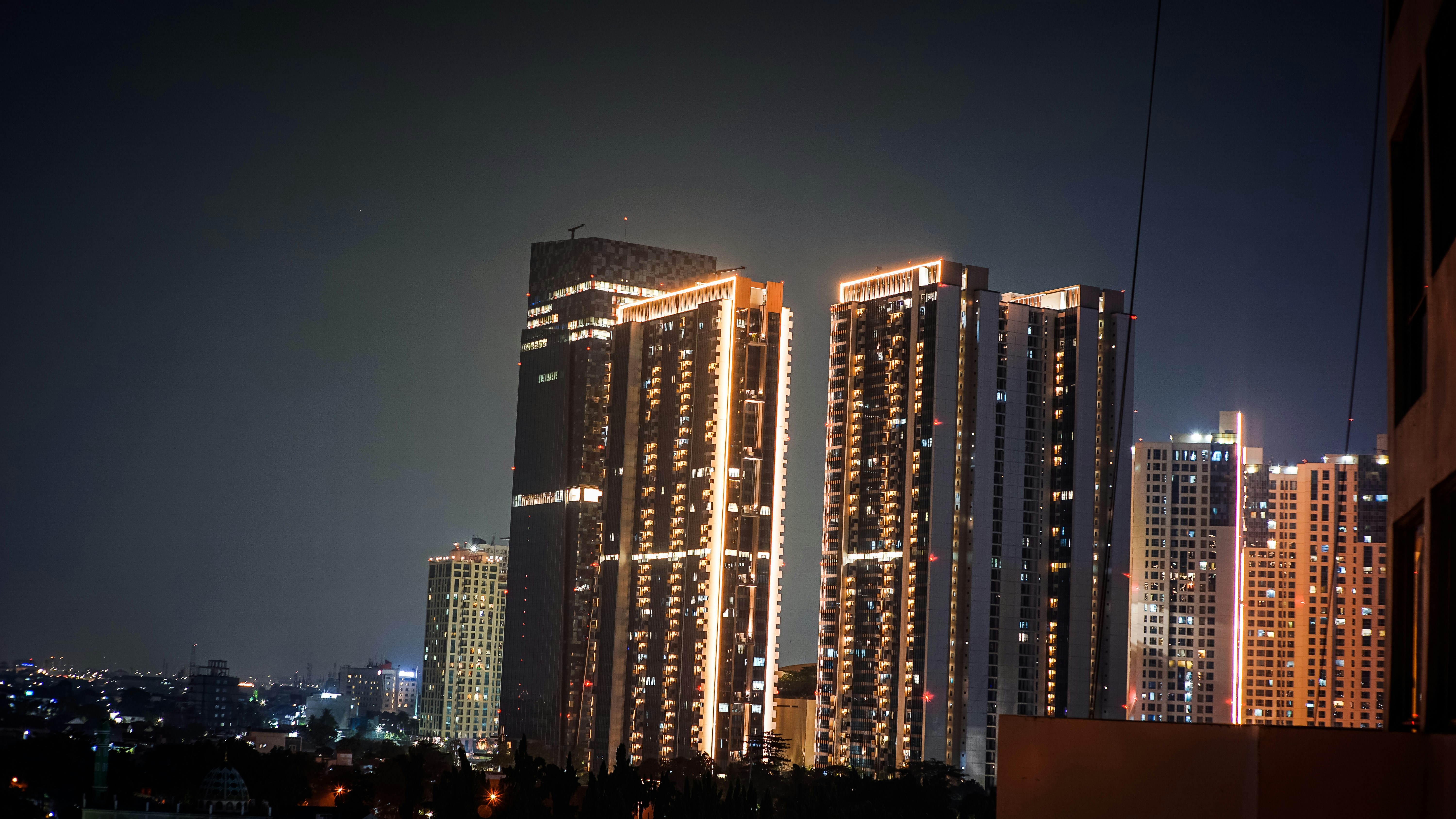 A very tall building with a lot of lights on it photo – Free Building ...