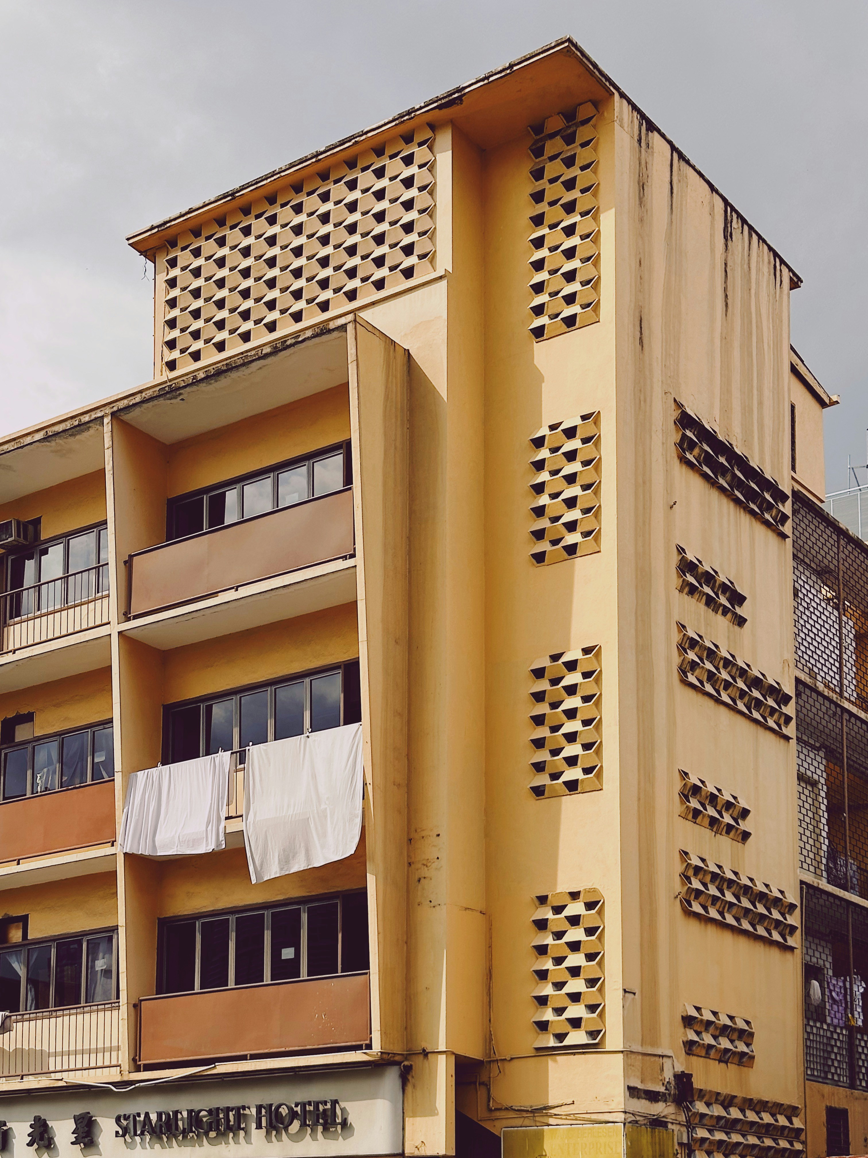 A building with a lot of windows and a laundry line on the outside of ...