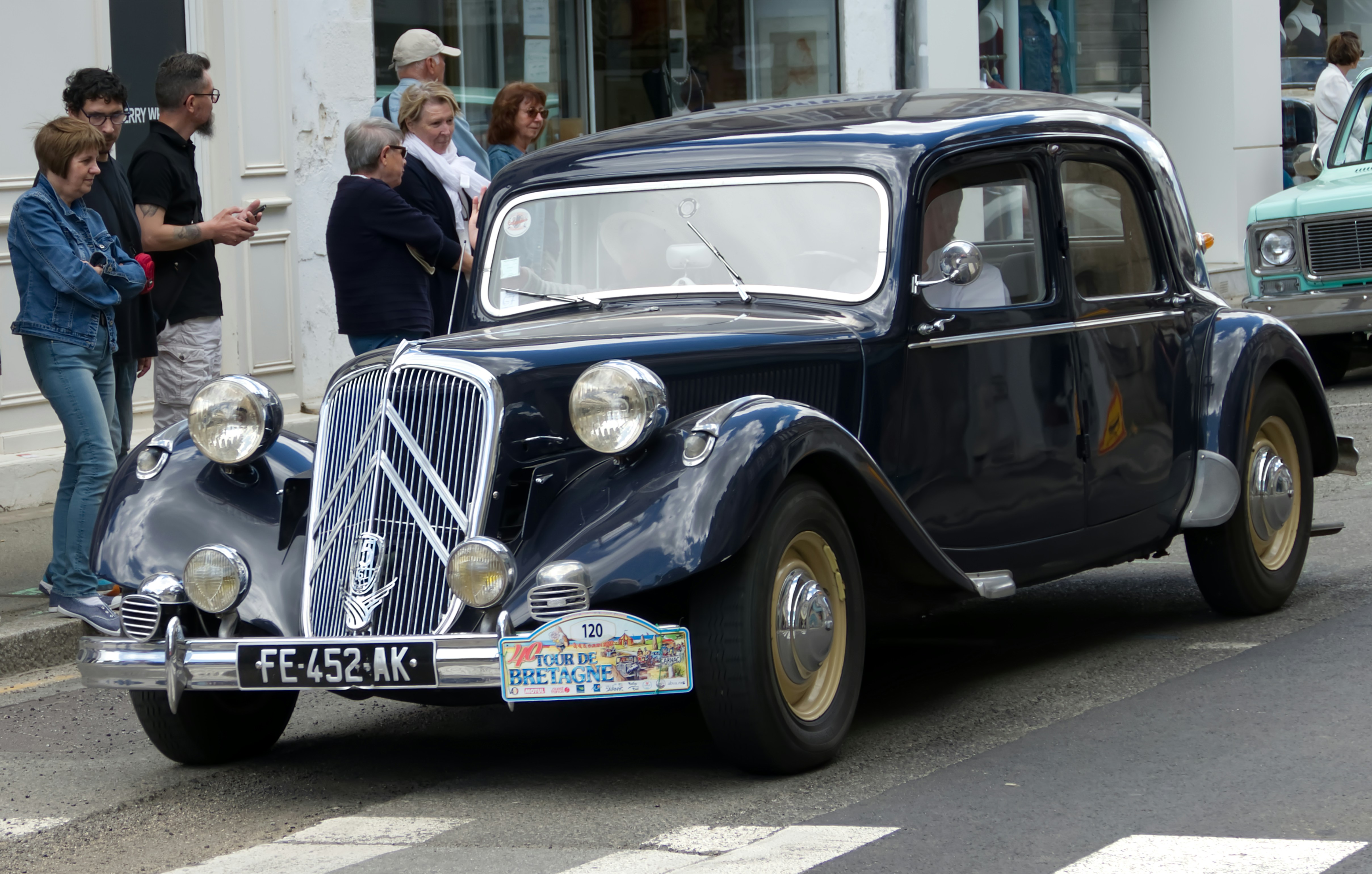 Elegy in Blue: A Classic Peugeot Rolls Through the Street