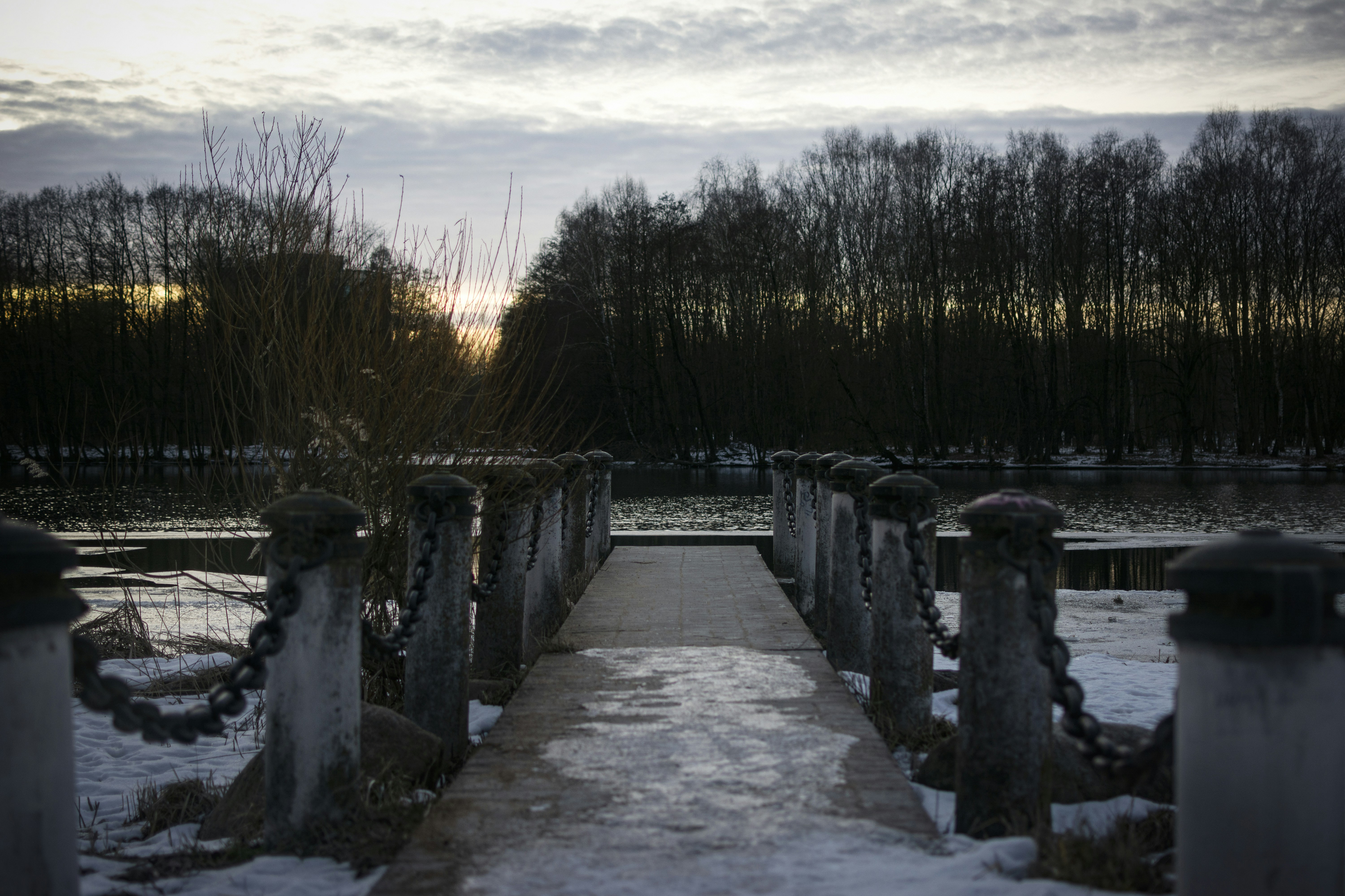 Vanishing Lines on a Frost-Blanketed Bridge at Dusk