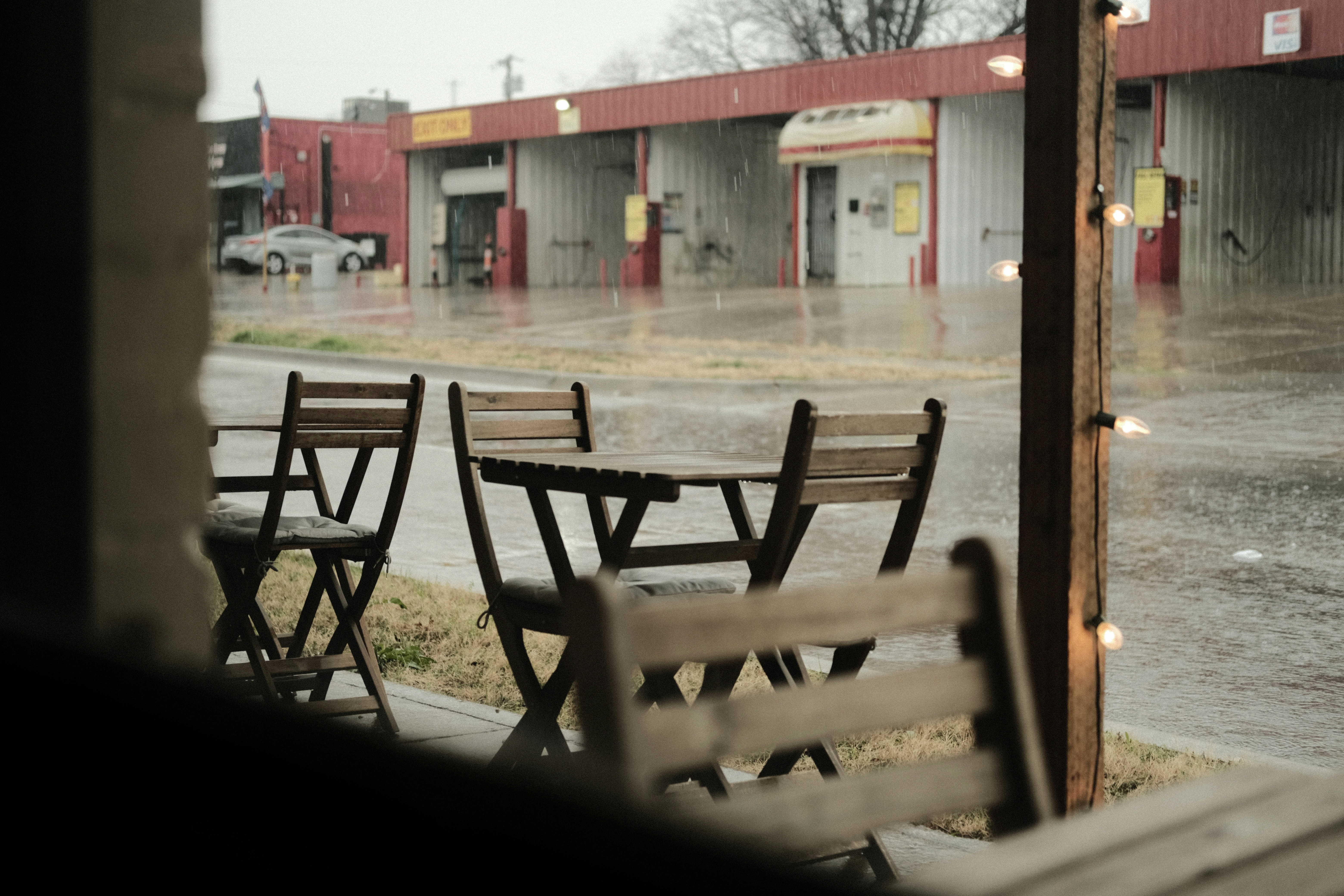 Rainy Café Terrace Overlooking a Quiet Street