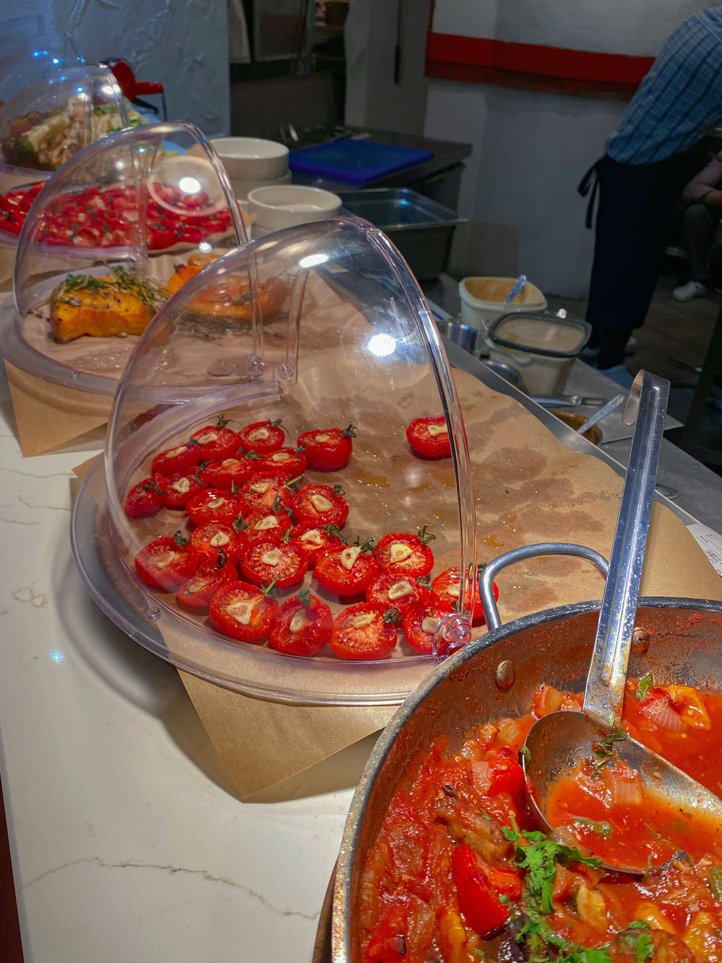 A table topped with bowls of food covered in tomatoes photo – Free ...