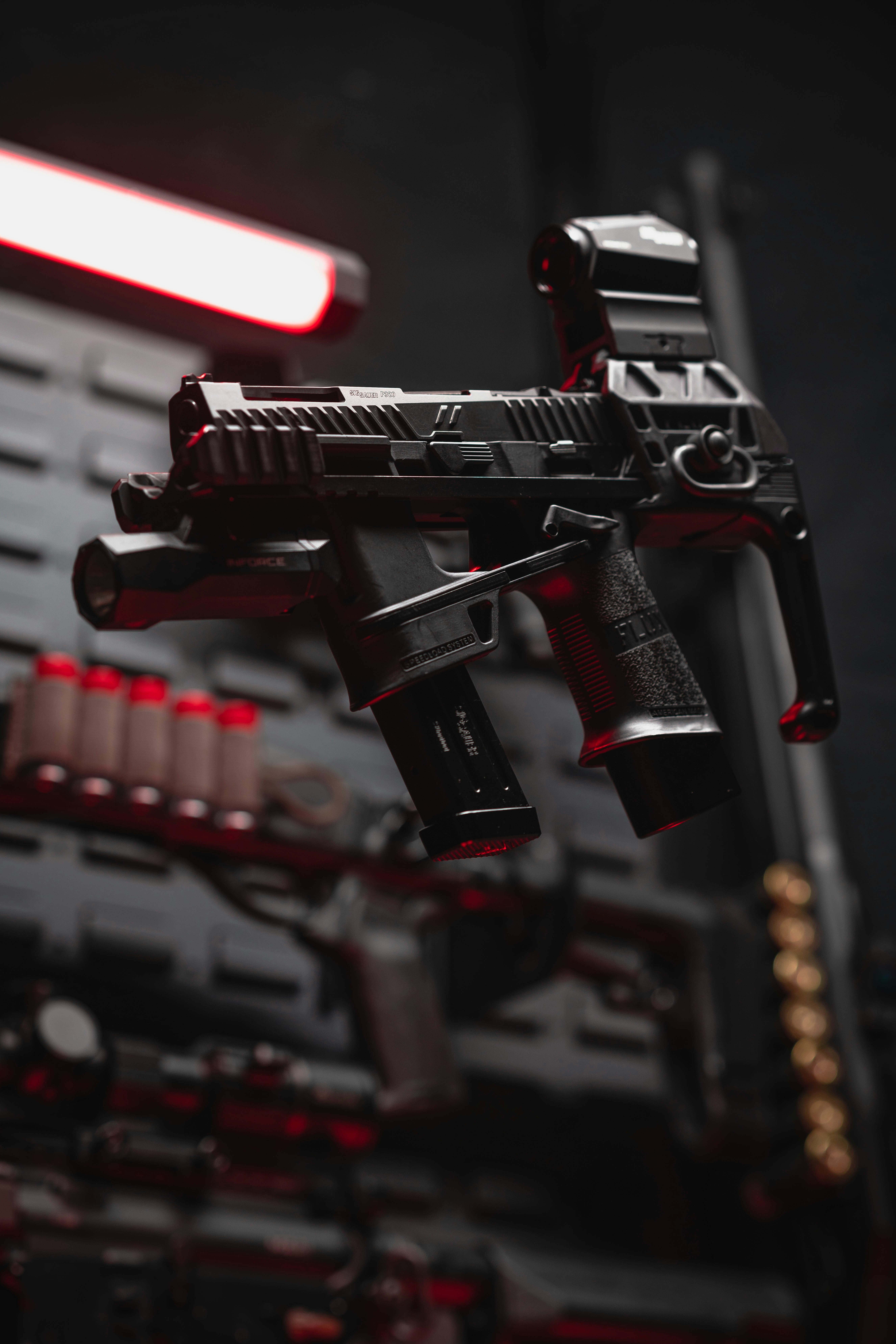 A close up of a machine gun in a room photo – Free Handgun Image on ...