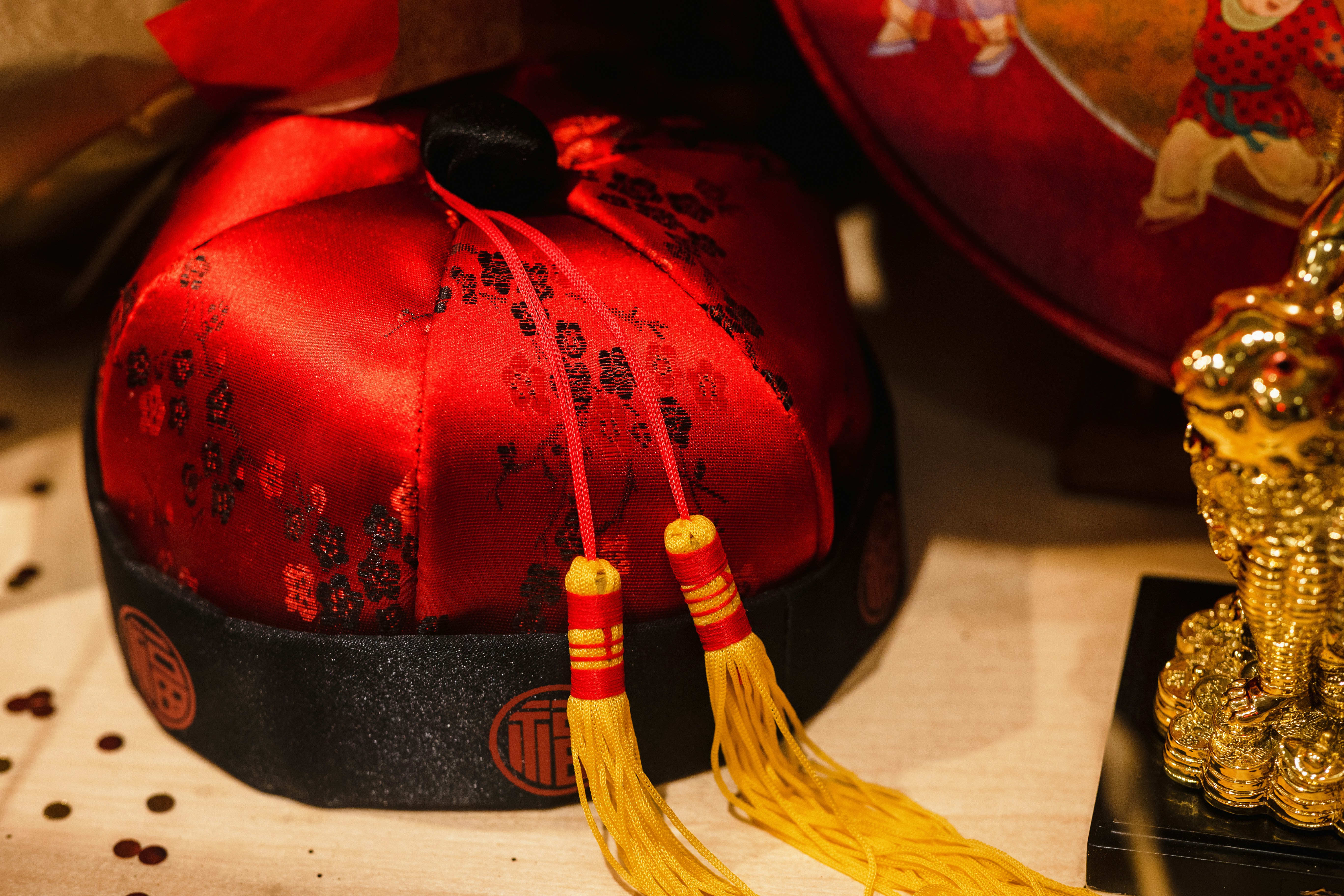 Scarlet Silk Orb with Golden Tassels on a Festive Table