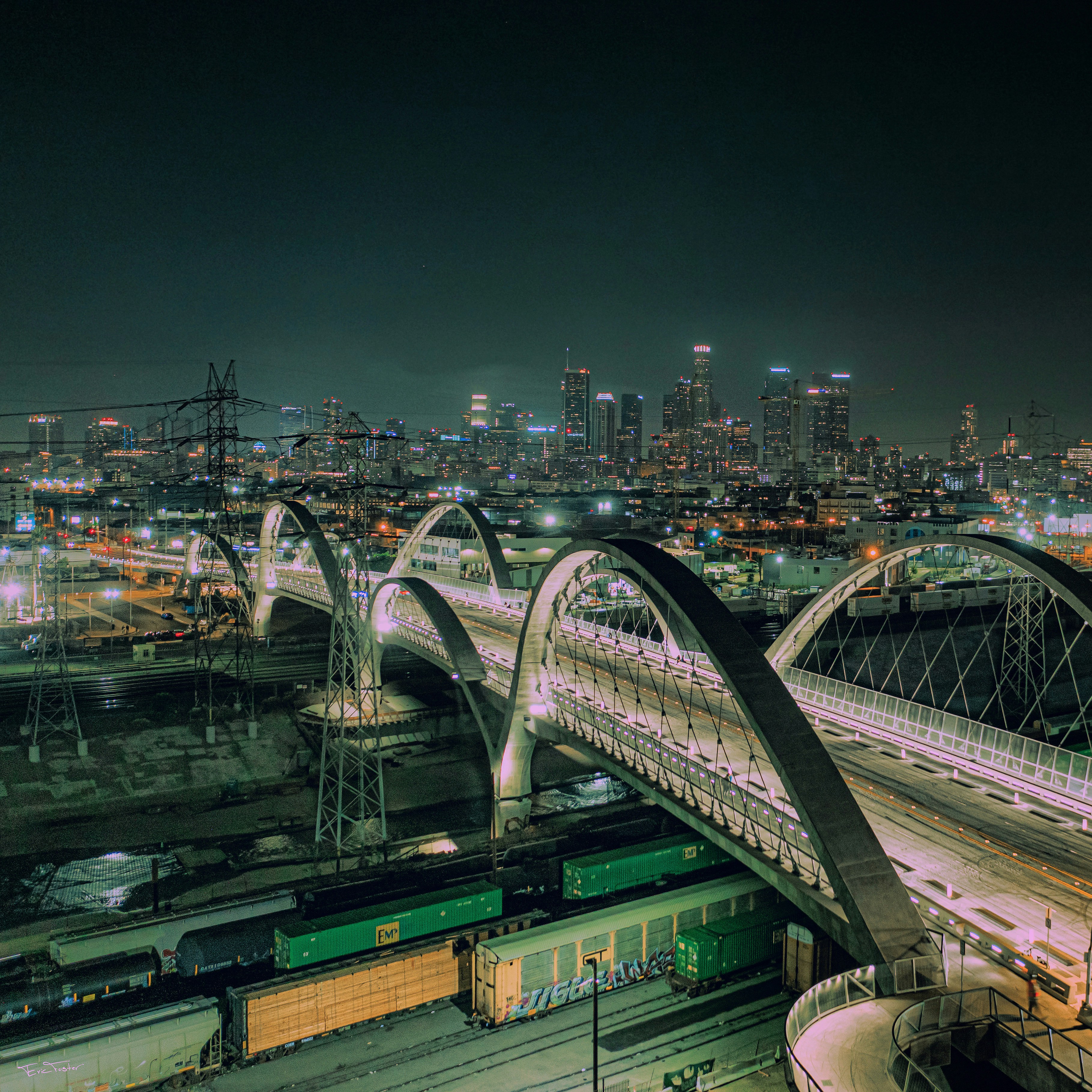 Neon Arches Over the Freight Yard: City Lights Beyond the Rails