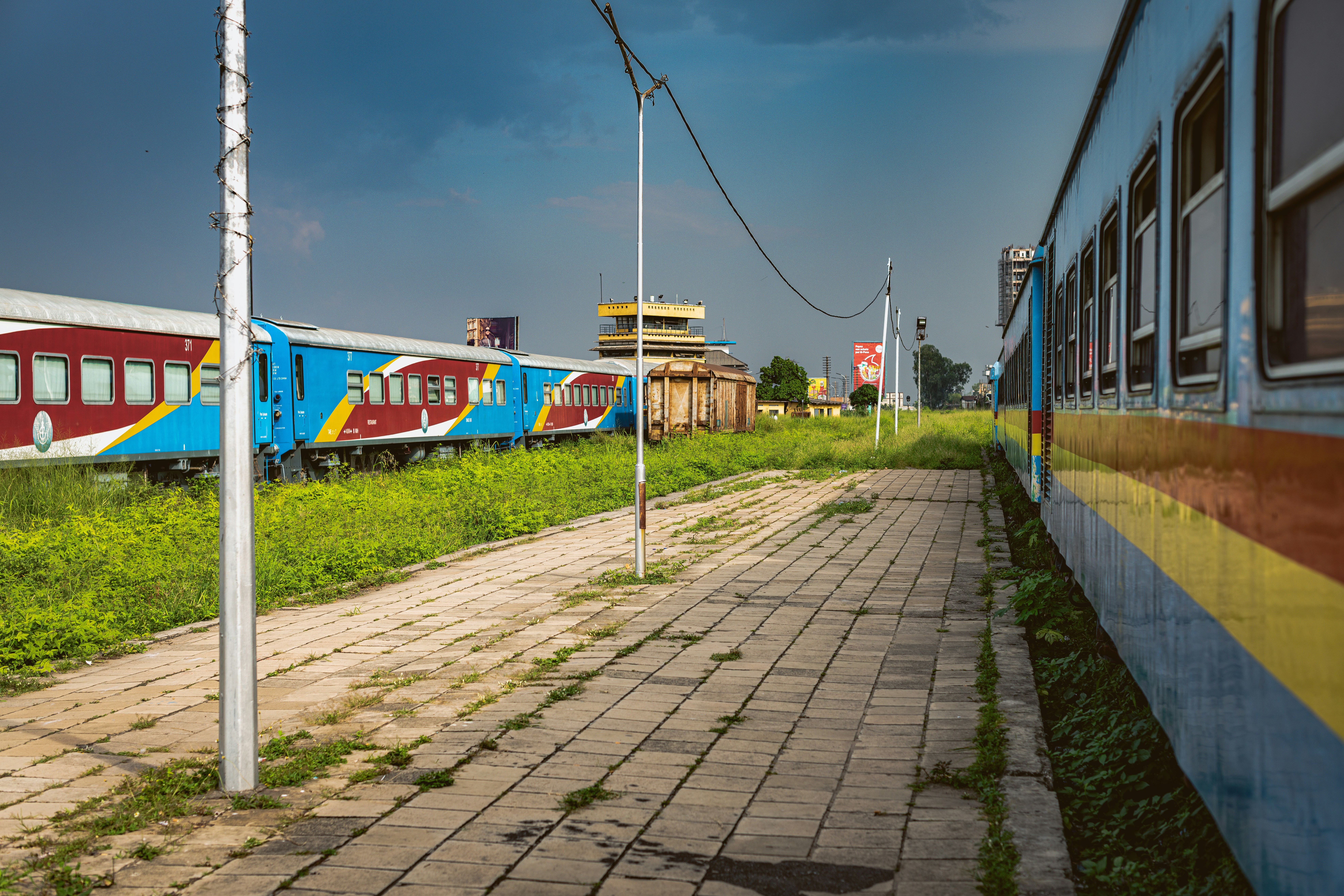 A train on a train track next to a grassy field photo – Free Train ...